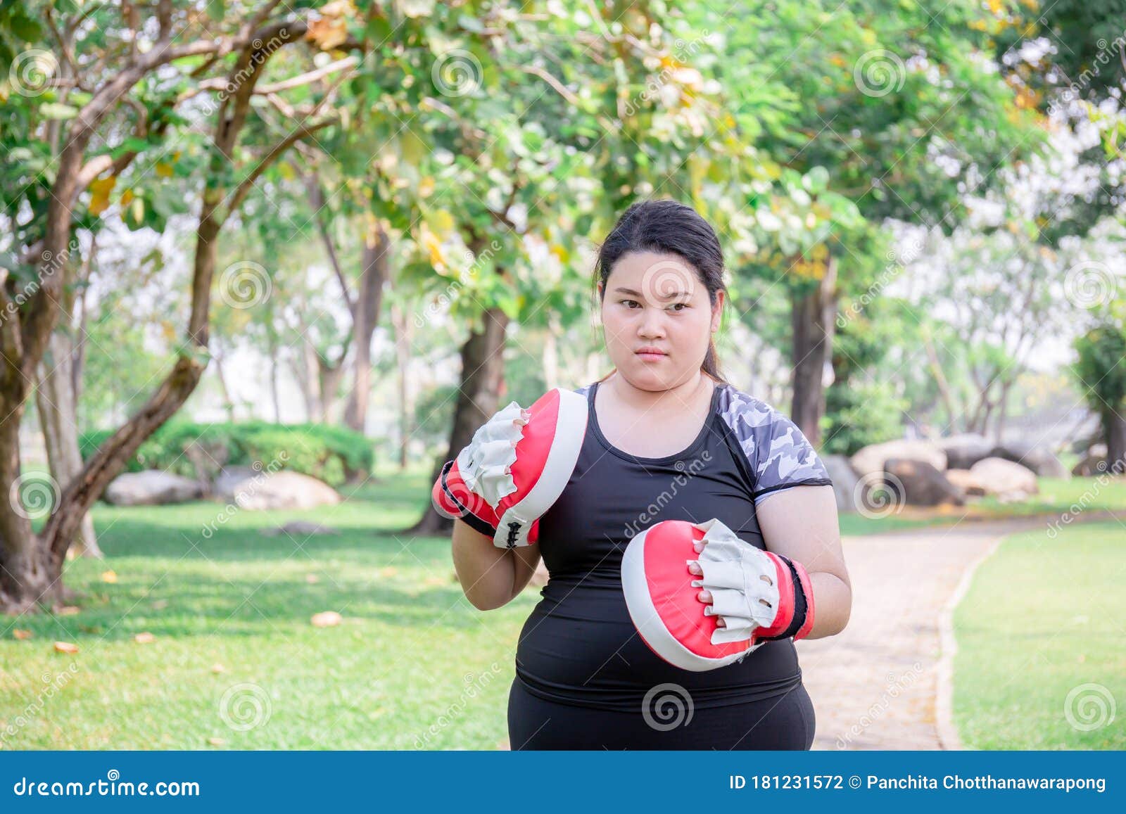 Young Plus Size Model Girl with Boxing Gloves in the Park Stock Photo ...