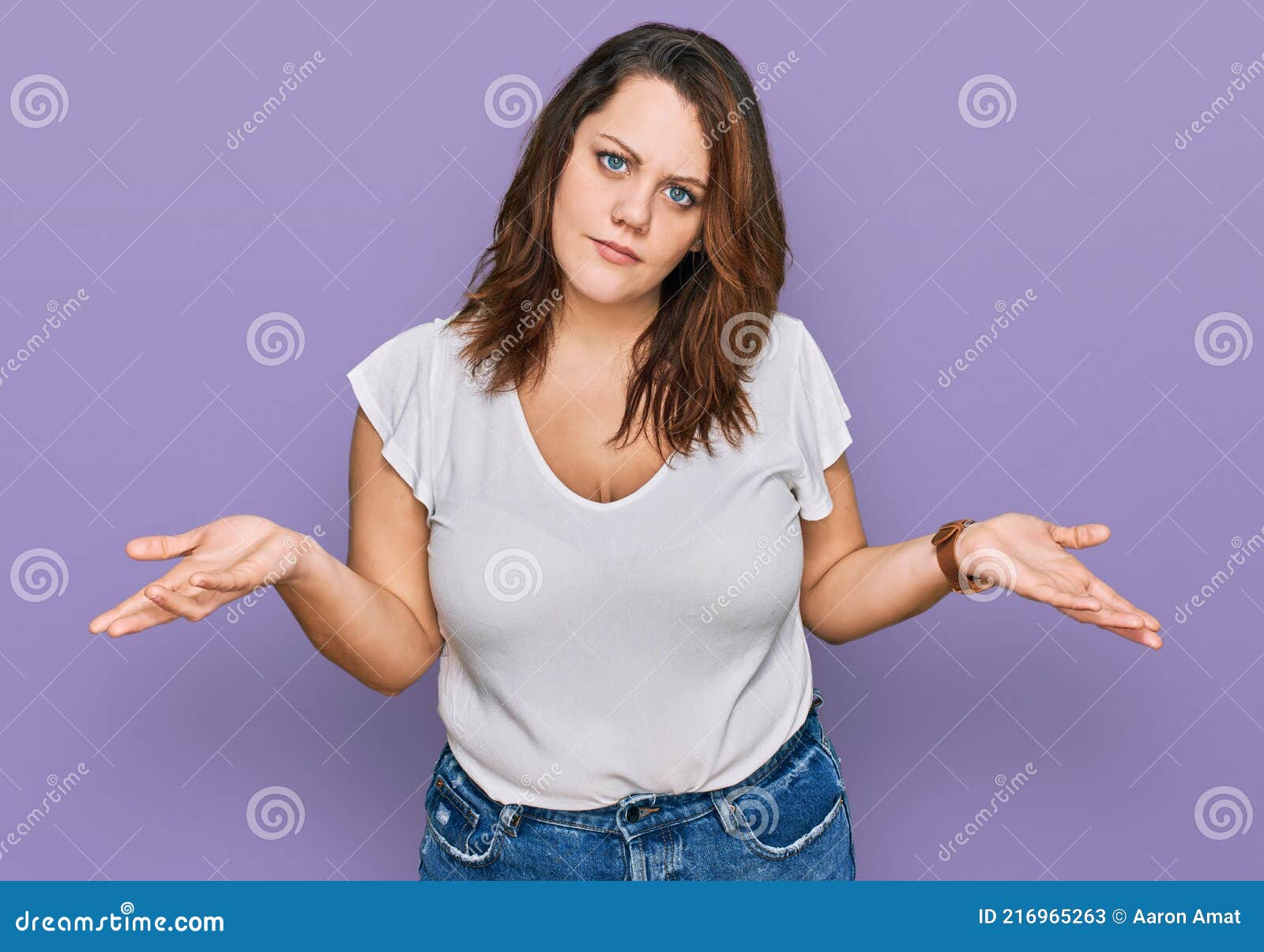 Young Plus Size Woman Wearing Casual White T Shirt Clueless And