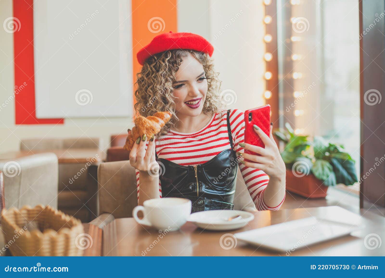 Young Positive Optimistic Woman with Red Smartphone in Cafe Stock Photo ...