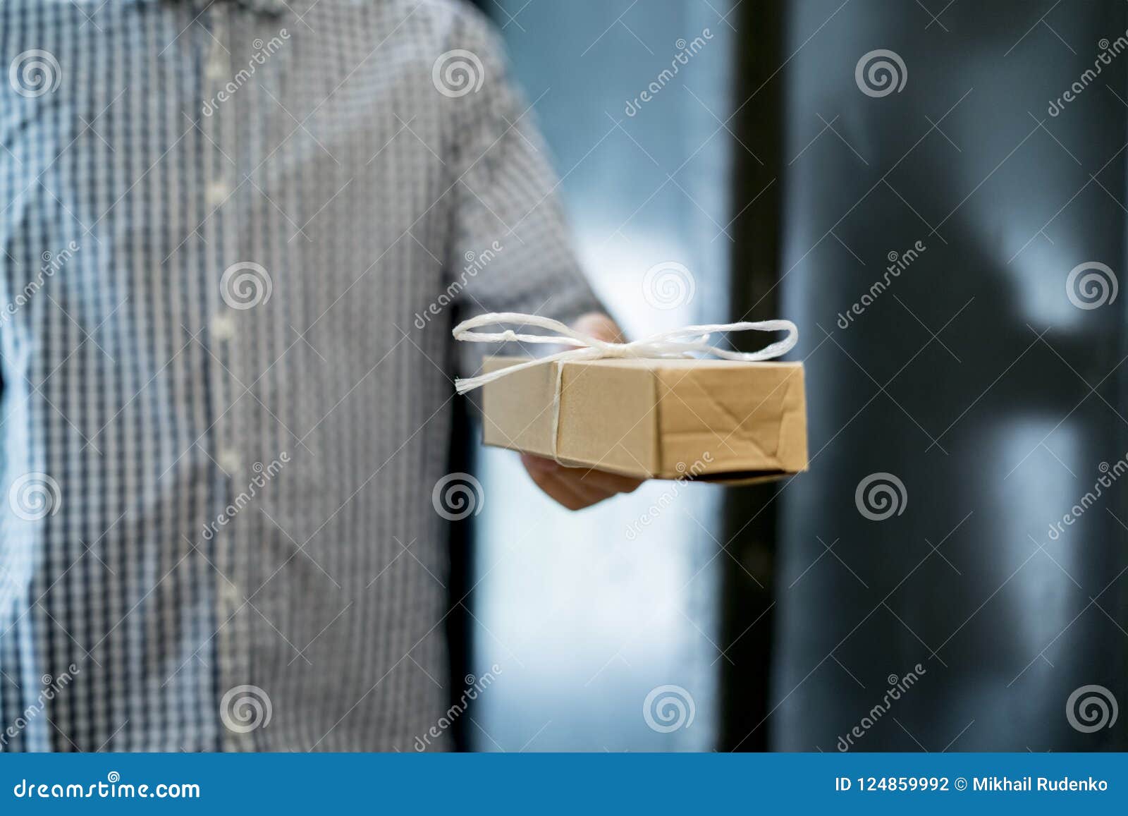 Young Postman Gives Box Package Delivery at Home Stock Photo - Image of ...
