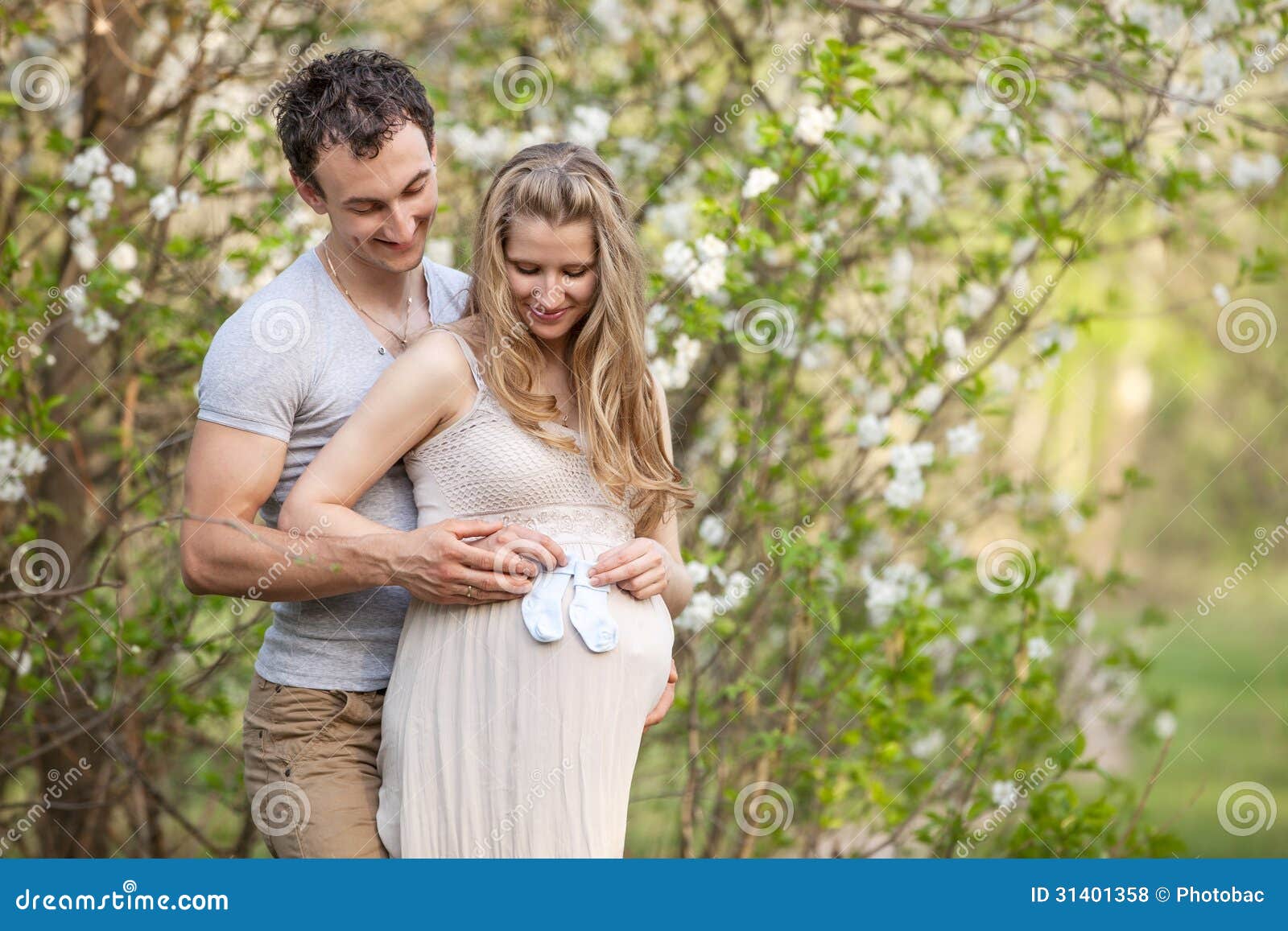 Young Pregnant Couple Outdoors in Spring Stock Photo - Image of couple ...