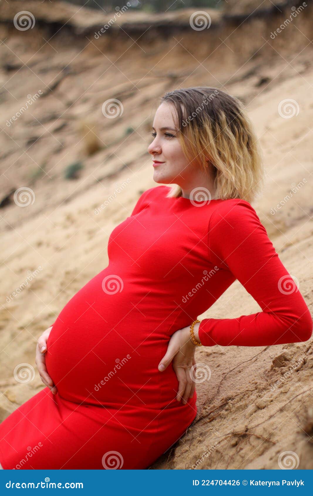 Young Pregnant Girl In A Red Dress On The Sand Pregnancy Is A Joy Big