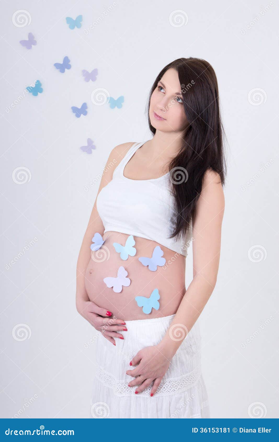 Young Pregnant Woman With Colorful Butterflies On Her Stomach Stock