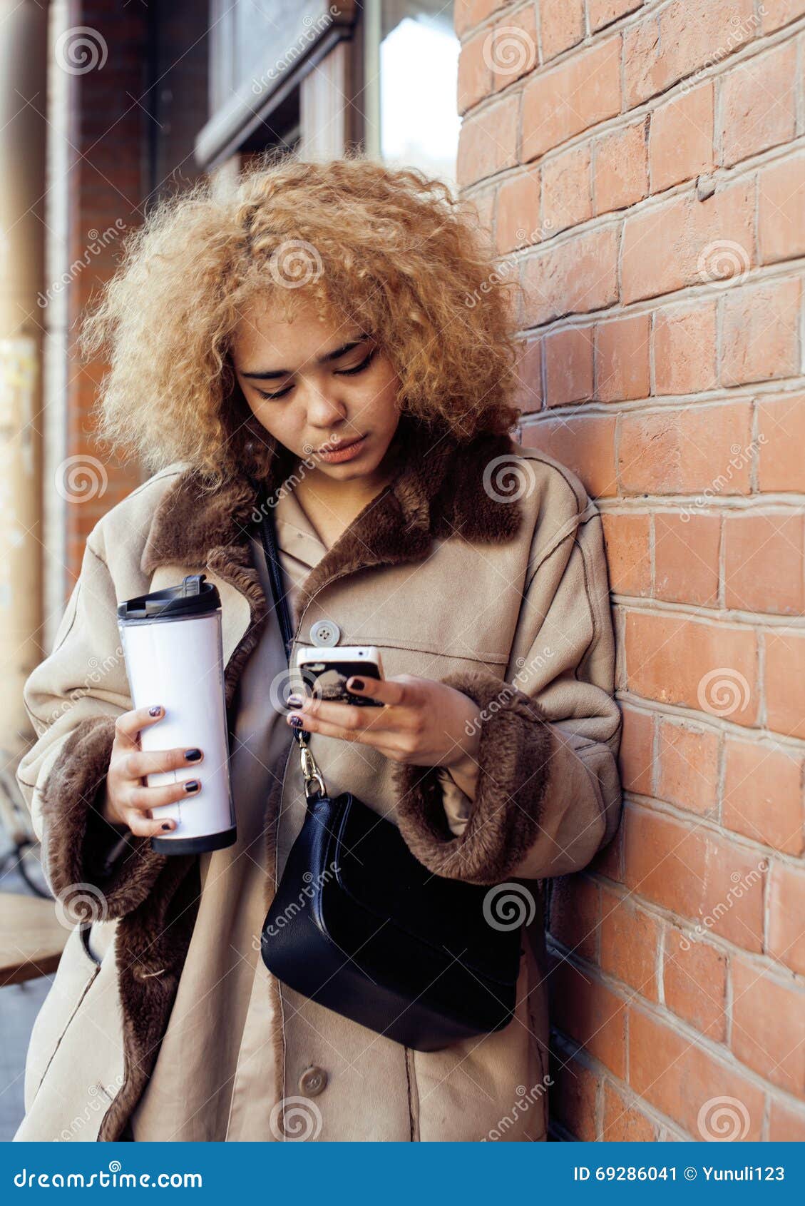 Young Pretty African American Women Drinking Coffee Outside In Cafe