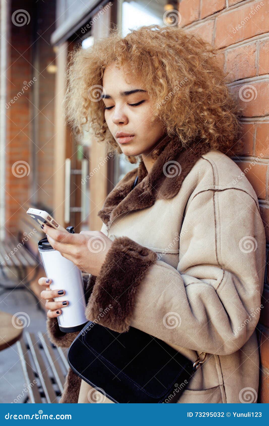 Young Pretty African American Women Drinking Coffee Outside In Cafe