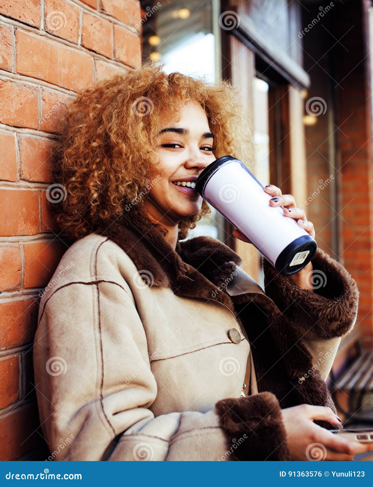 Young Pretty African American Women Drinking Coffee Outside In Cafe