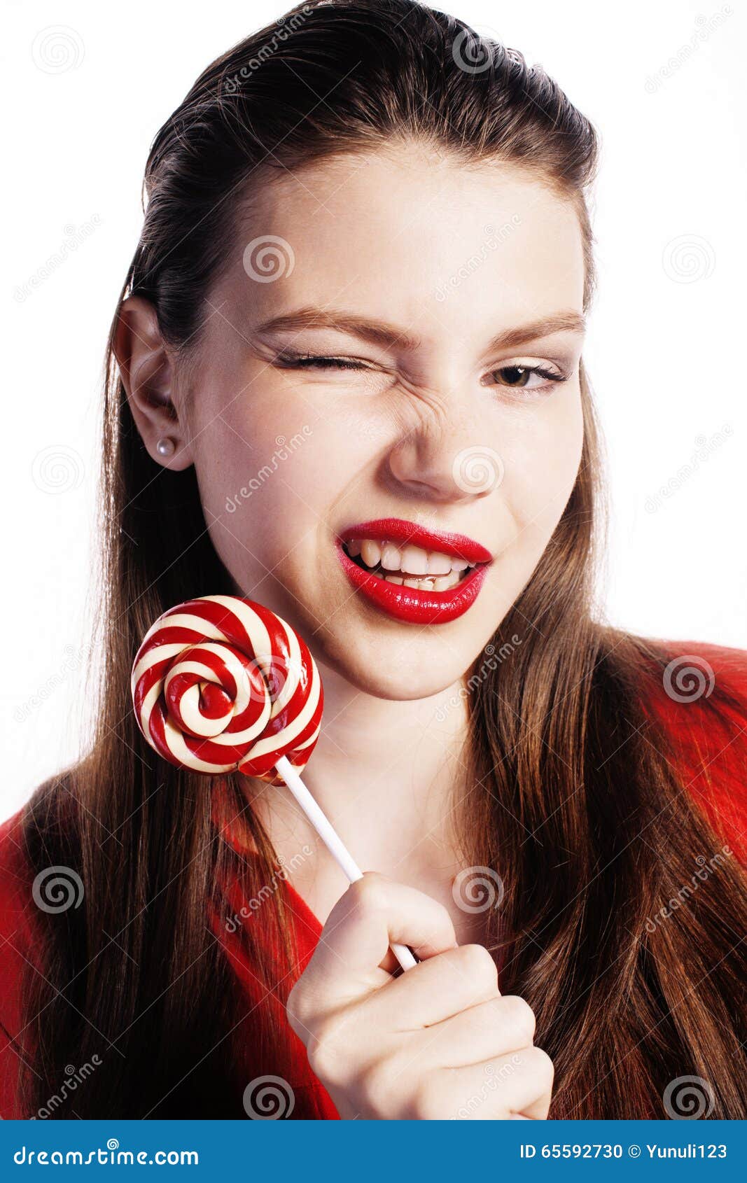 Young Pretty Brunette Girl With Red Candy Posing On White Background