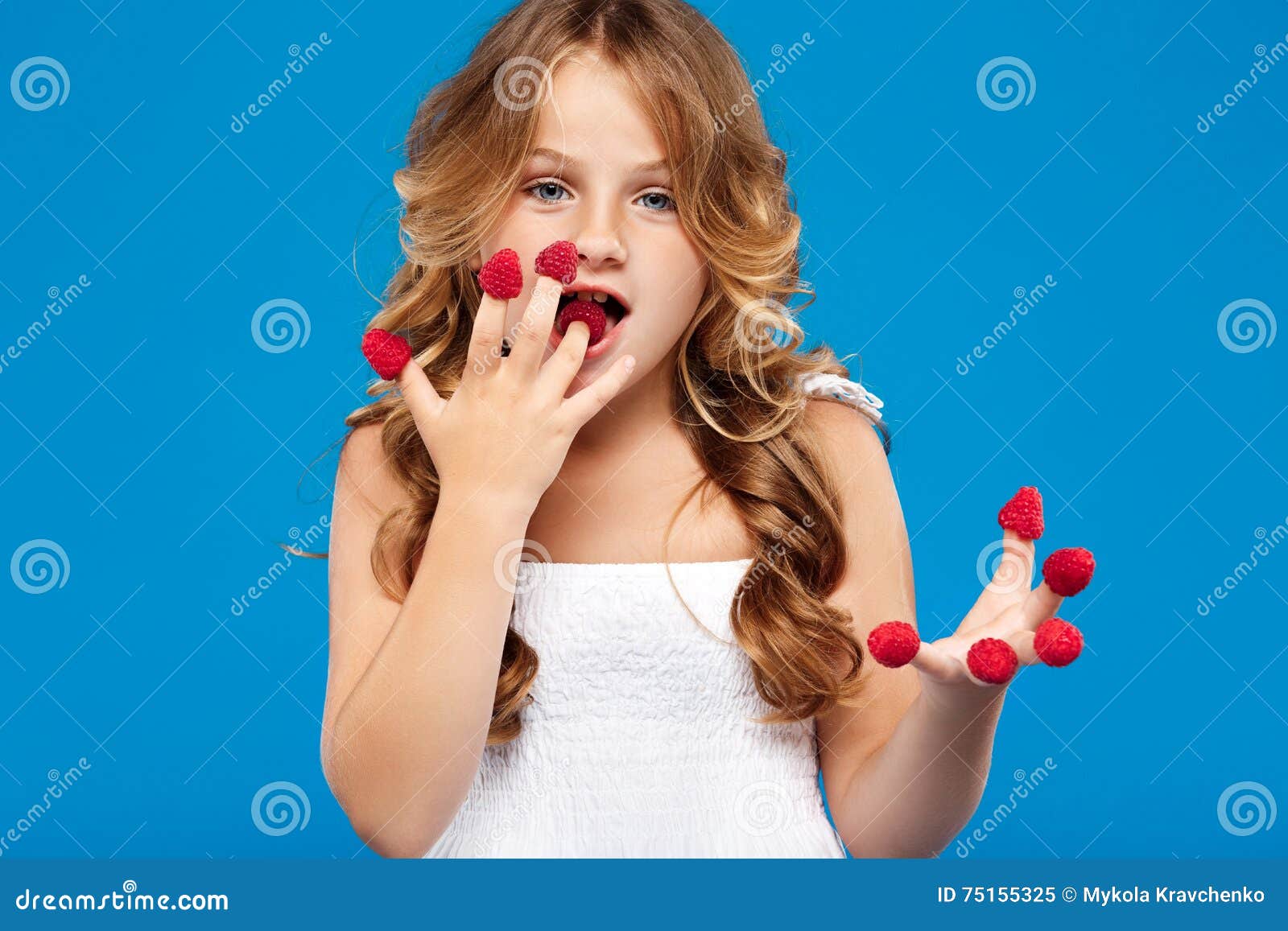 Young Pretty Girl Eating Raspberry Over Blue Background. Stock Image ...