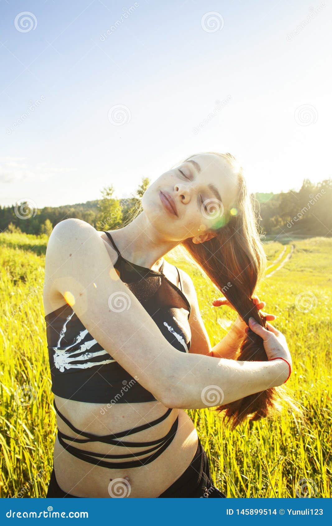Young Pretty Girl Posing Cheerful In Green Grass Outside Enjoing