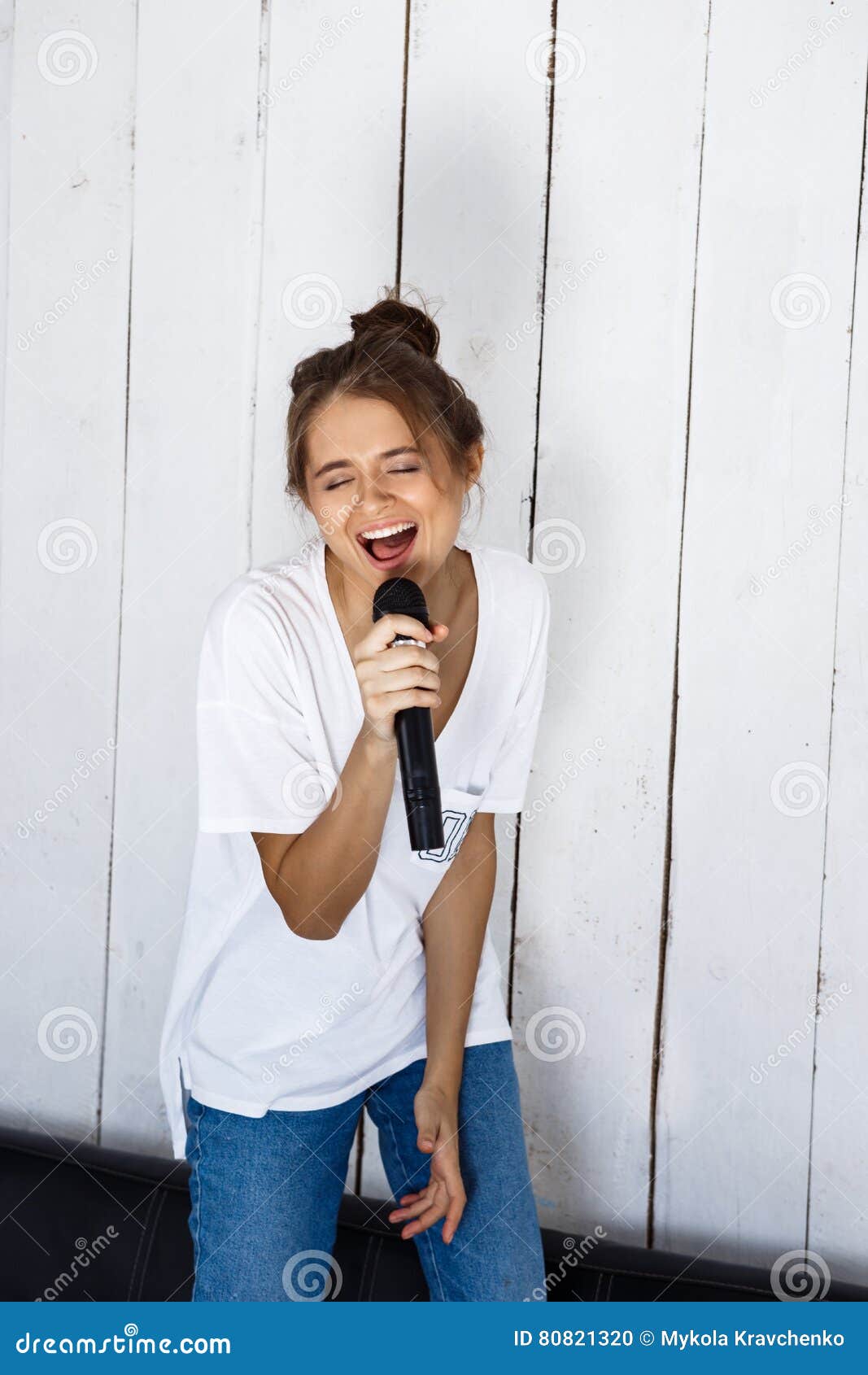Young Pretty Girl Singing in Microphone on Sofa at Home. Stock Photo ...