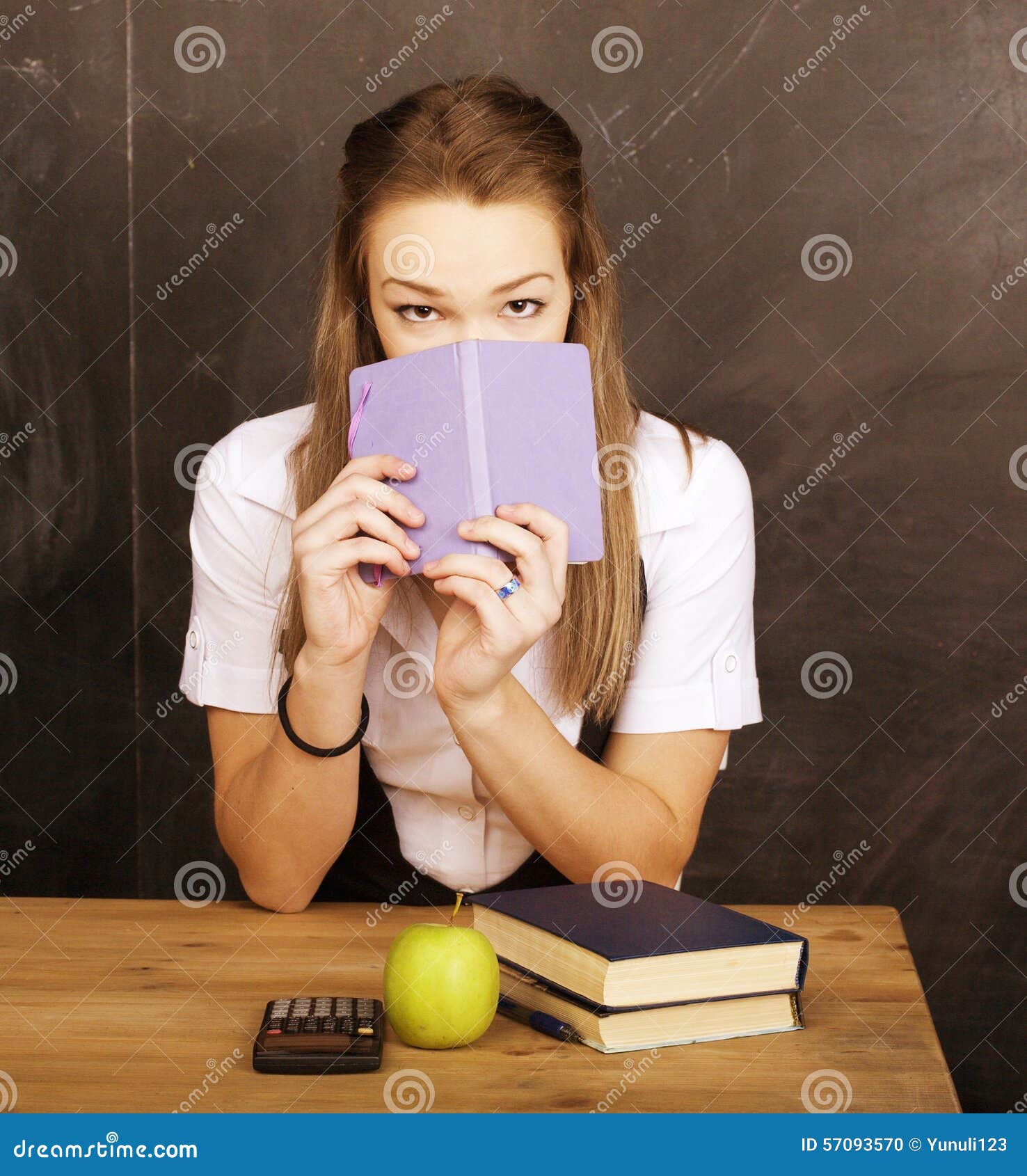 Young Pretty Girl Student in Classroom at Stock Photo - Image of apple ...