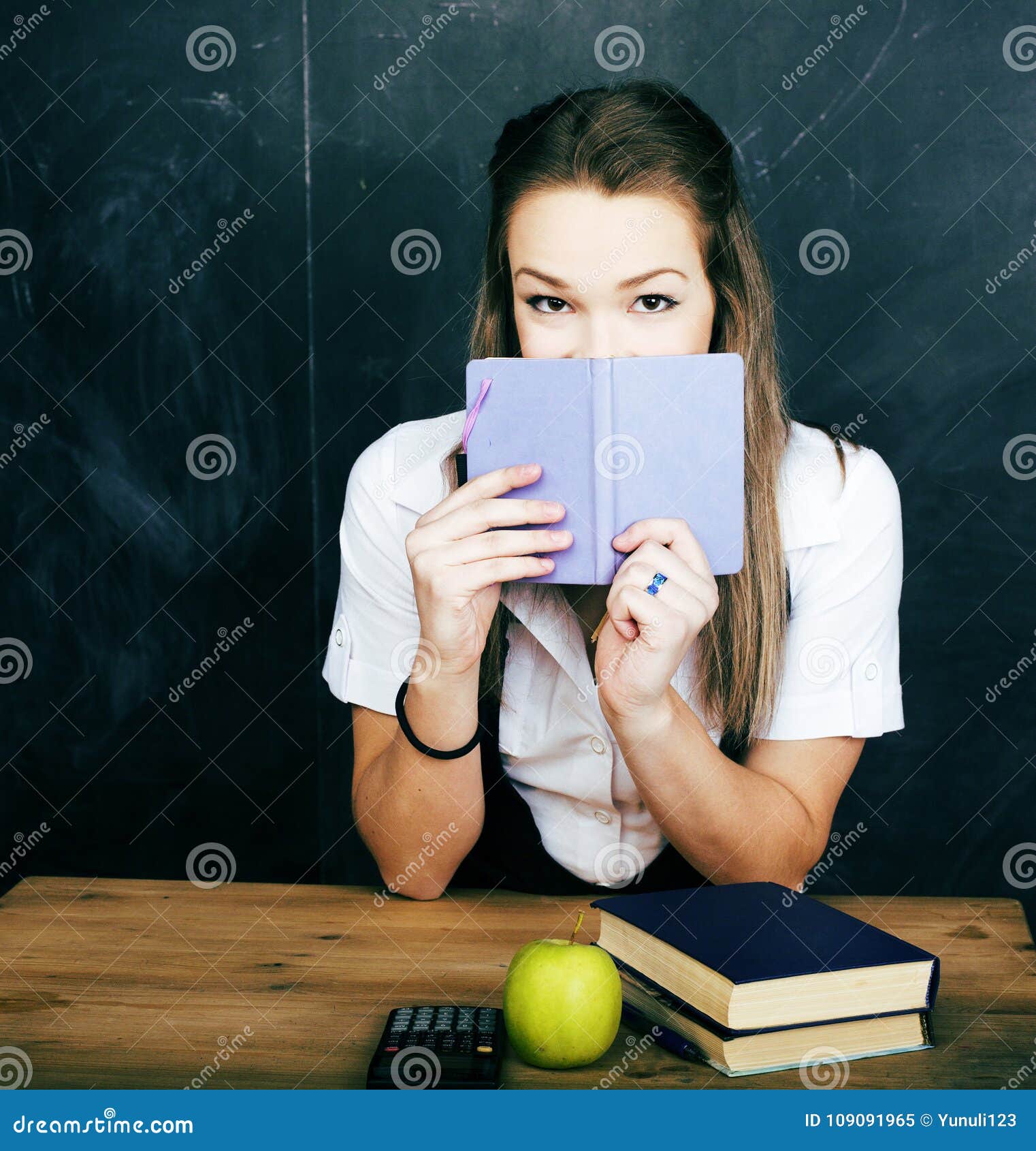Young Pretty Girl Student in Classroom at Blackboard Doing Homework ...