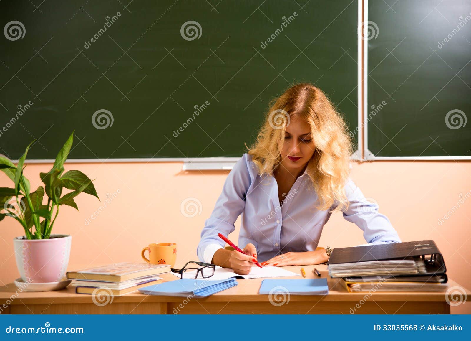 Young Pretty Teacher Checking the Tests. Stock Photo - Image of female ...