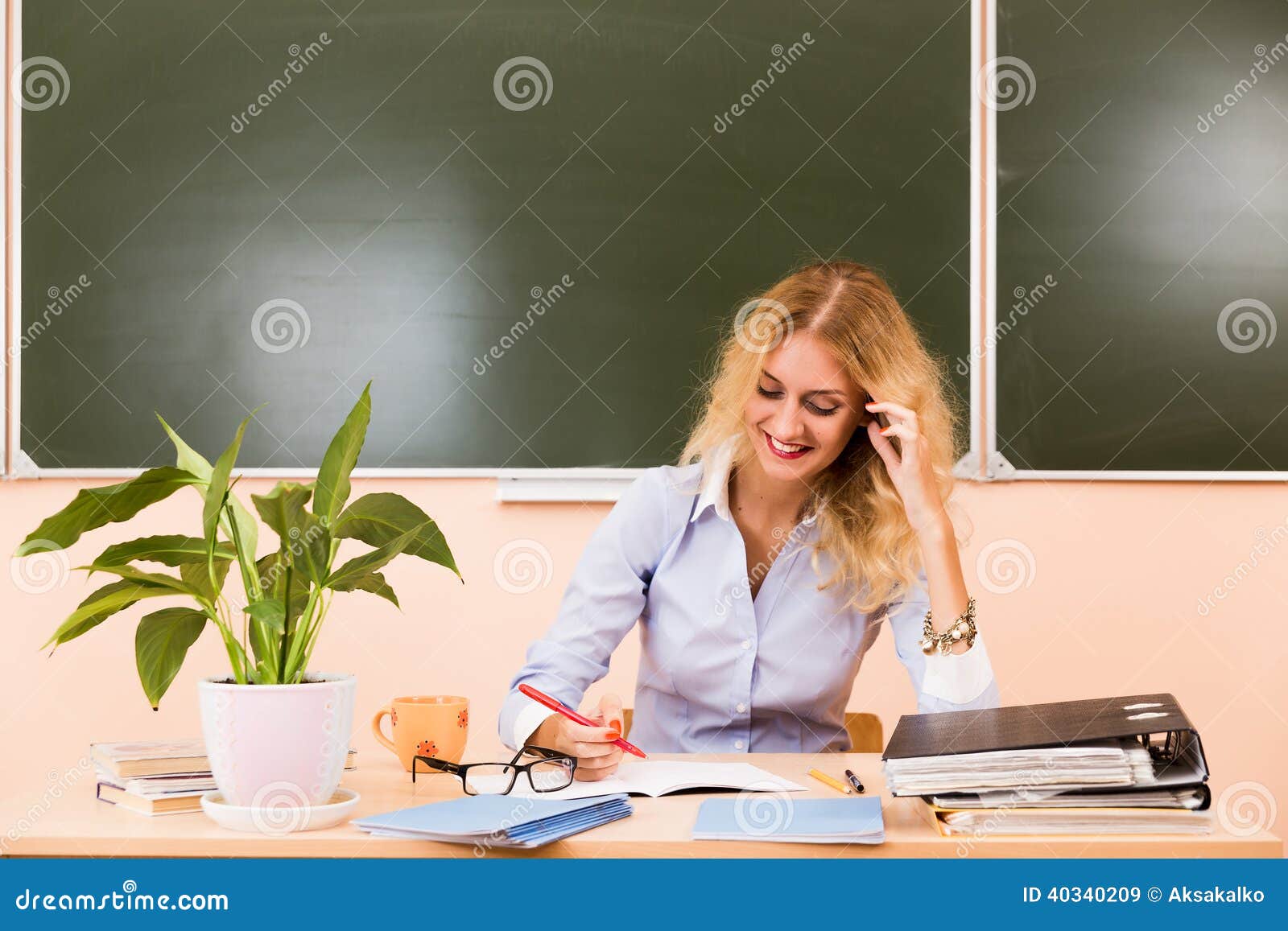 Young Pretty Teacher Checking the Tests. Stock Image - Image of reading ...