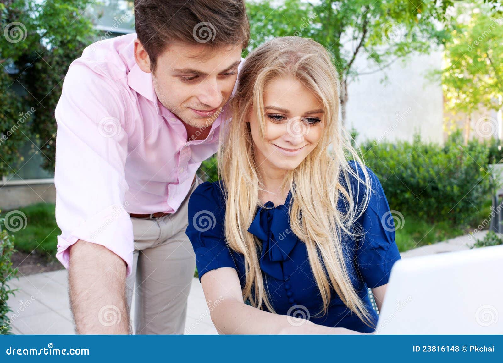 Young Professional Couple on Laptop Stock Photo - Image of looking ...