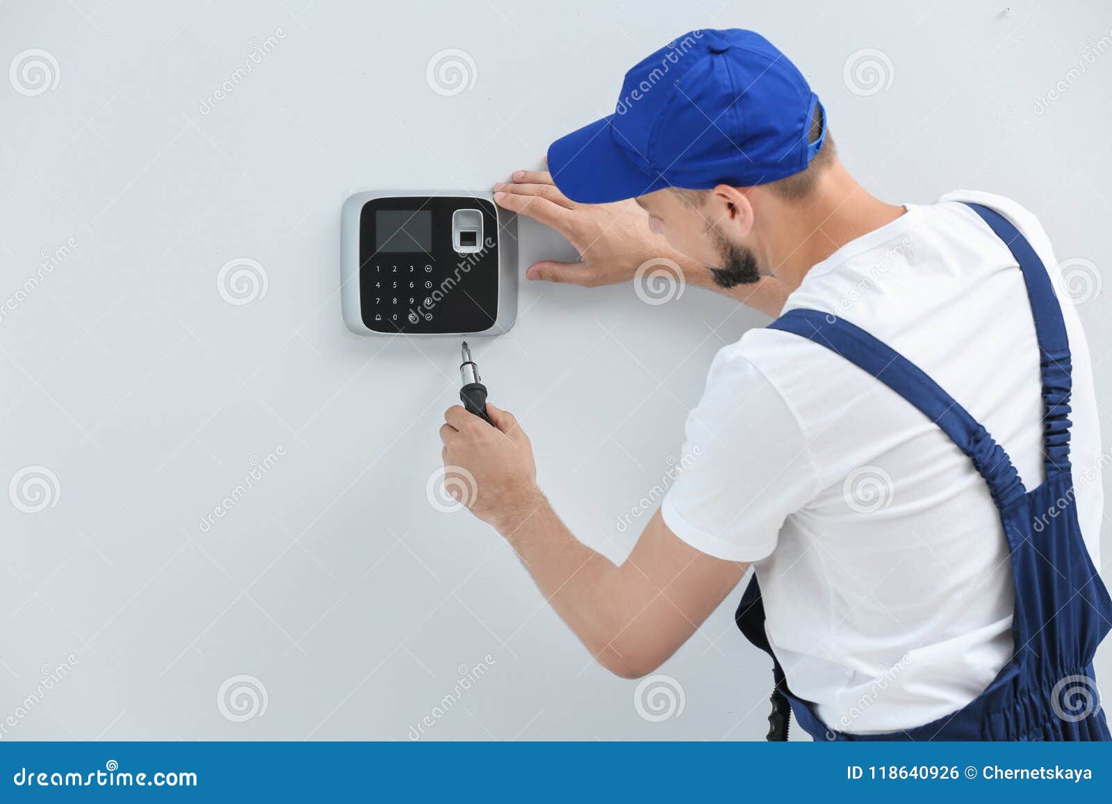 Young Male Technician Installing Alarm System Indoors Stock Photo ... Young Male Technician Installing Alarm System Indoors Stock Photo ...