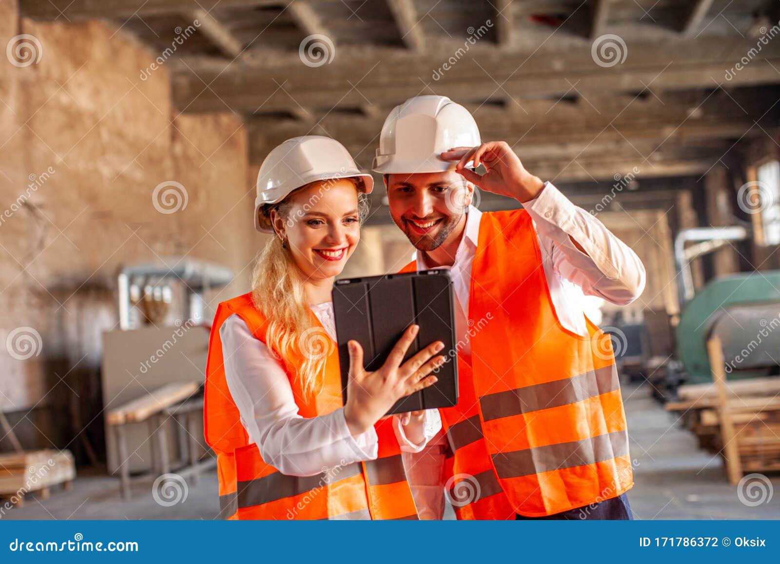 Young Professional People with Helmets Working in Quality Control in ...