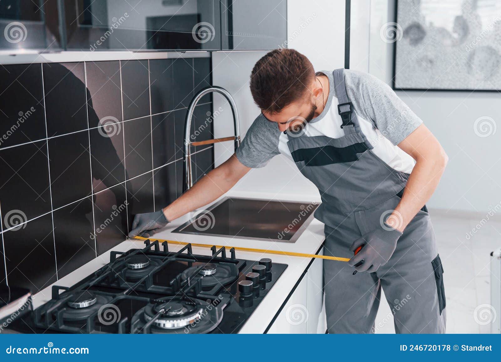 Young Professional Plumber in Grey Uniform Measuring Table by Using ...