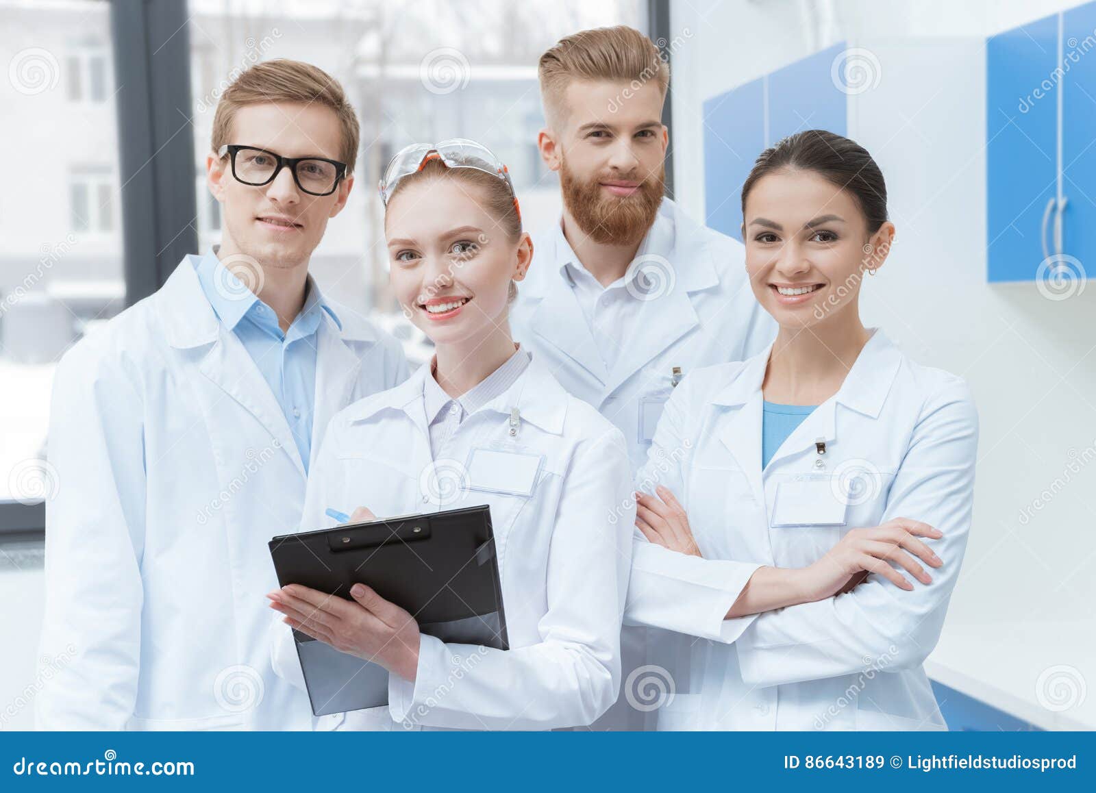 Young Professional Scientists in Lab Coats Smiling at Camera Stock ...