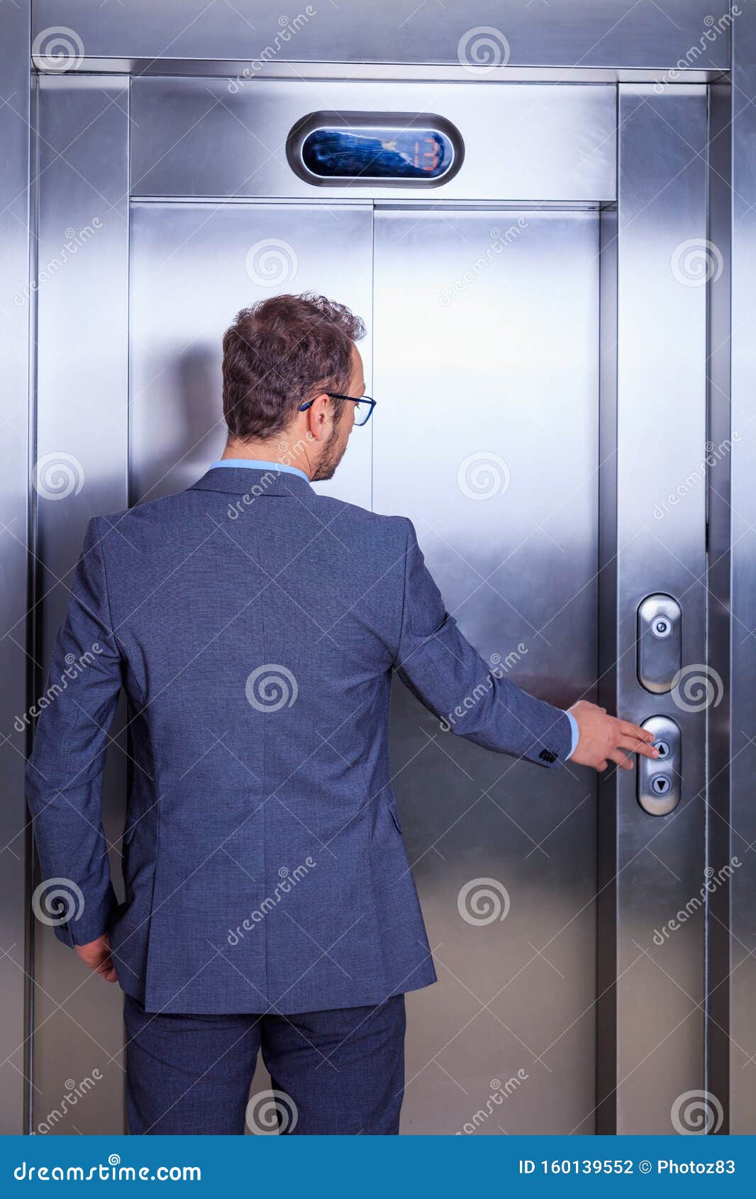 Young Professional in Suit Waiting in Front of the Elevator Stock Photo ...