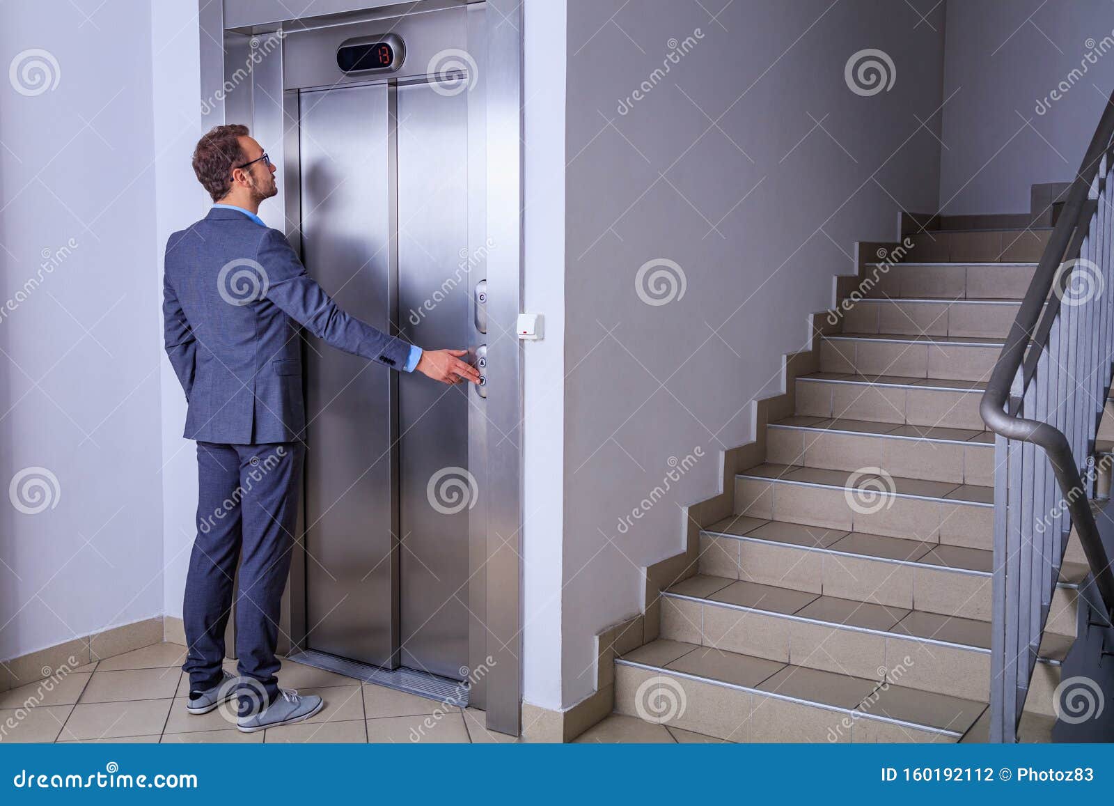 Young Professional in Suit Waiting in Front of the Elevator Stock Photo ...
