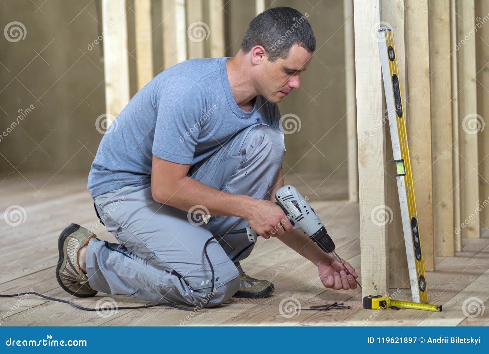 Young Professional Worker Uses Level and Screwdriver Installing Stock ...
