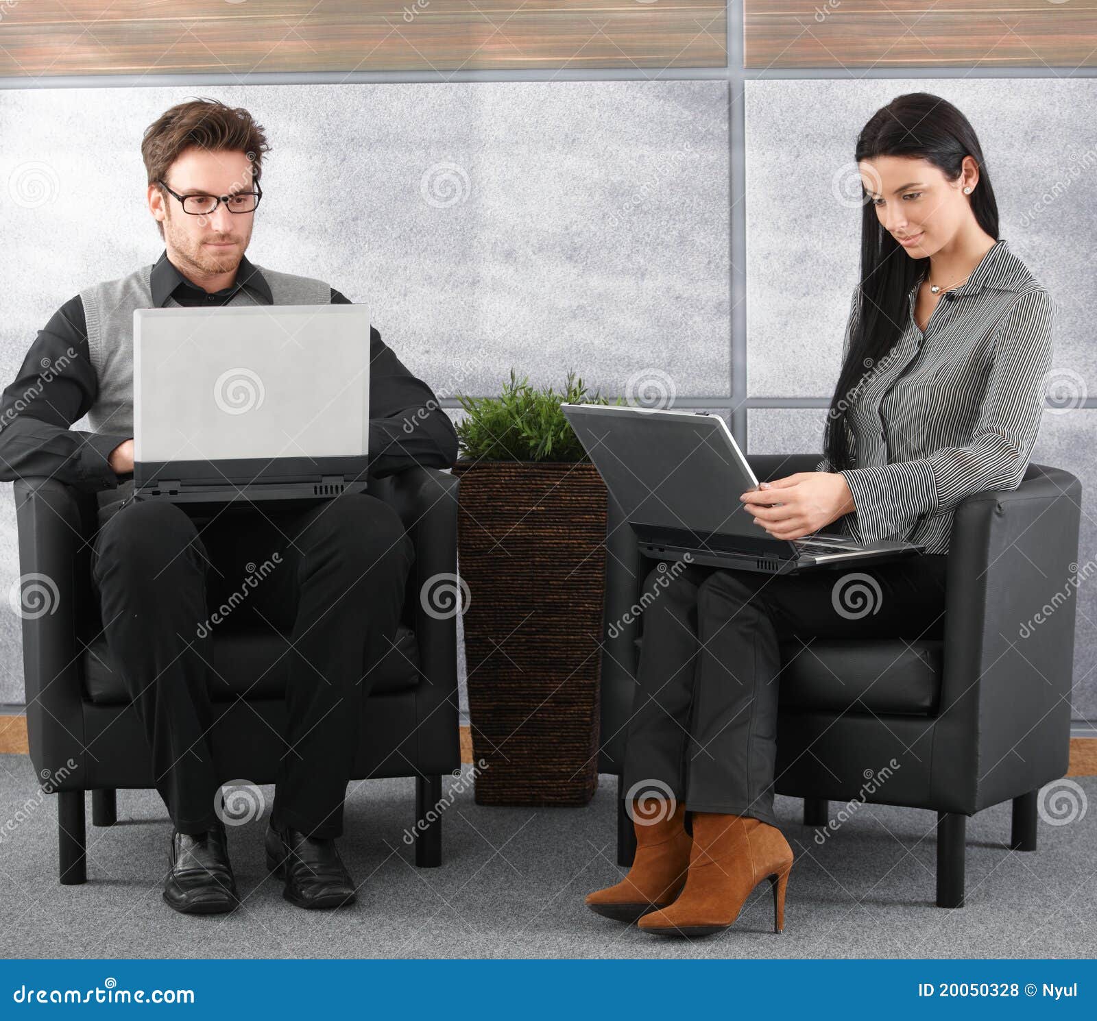 Young Professionals in Office Lobby with Laptop Stock Photo - Image of ...