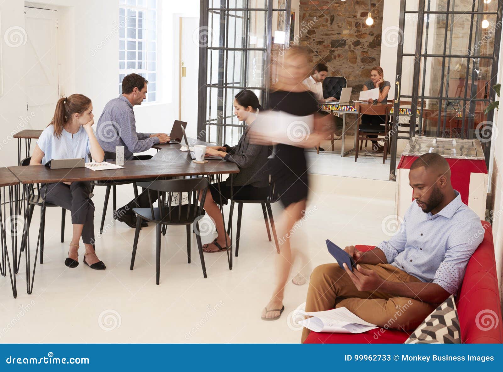 Young Professionals Working in a Busy Open Plan Office Stock Image ...