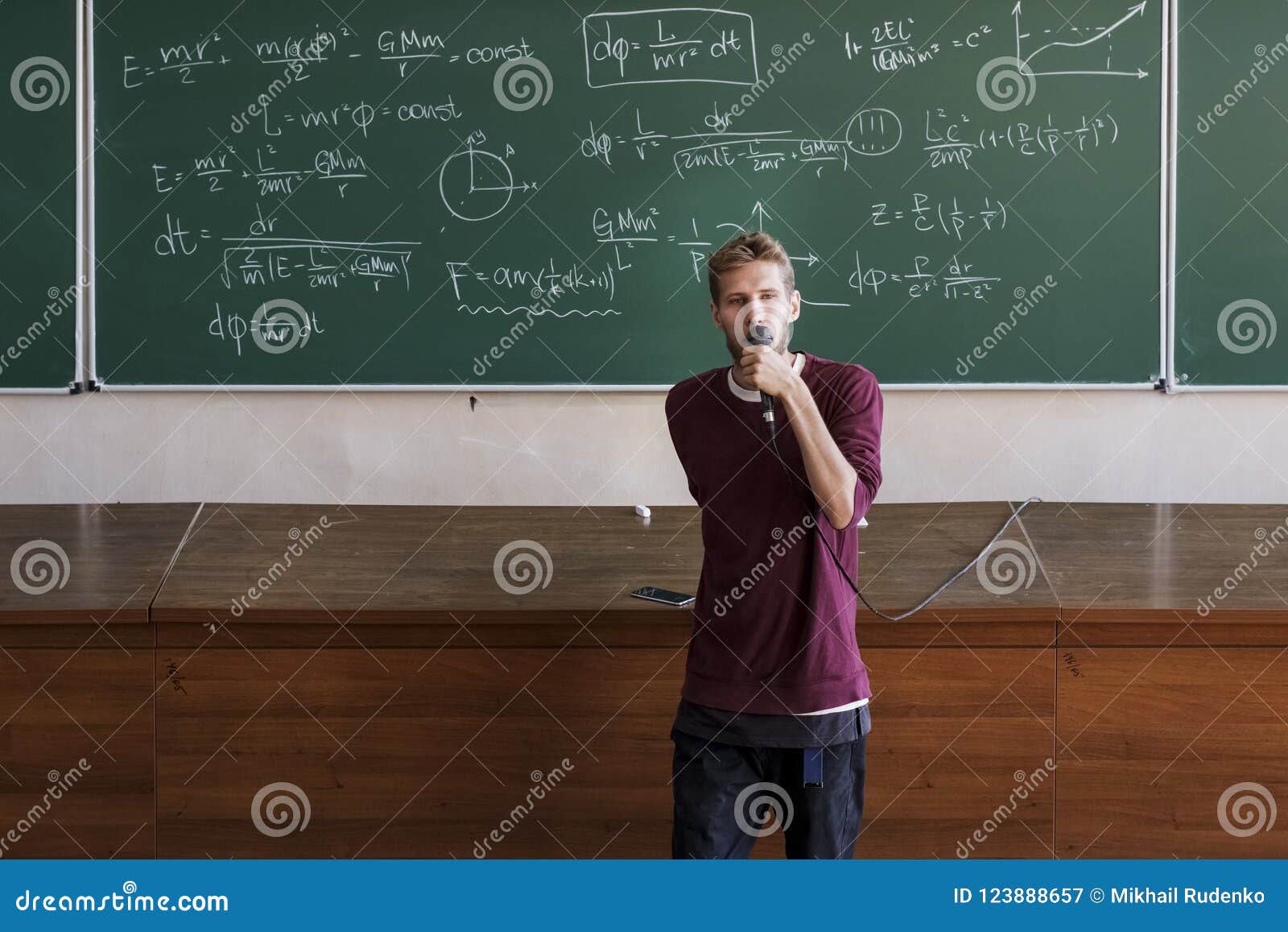 Young Professor Lecturer with Microphone Speaking and Teaching Students ...