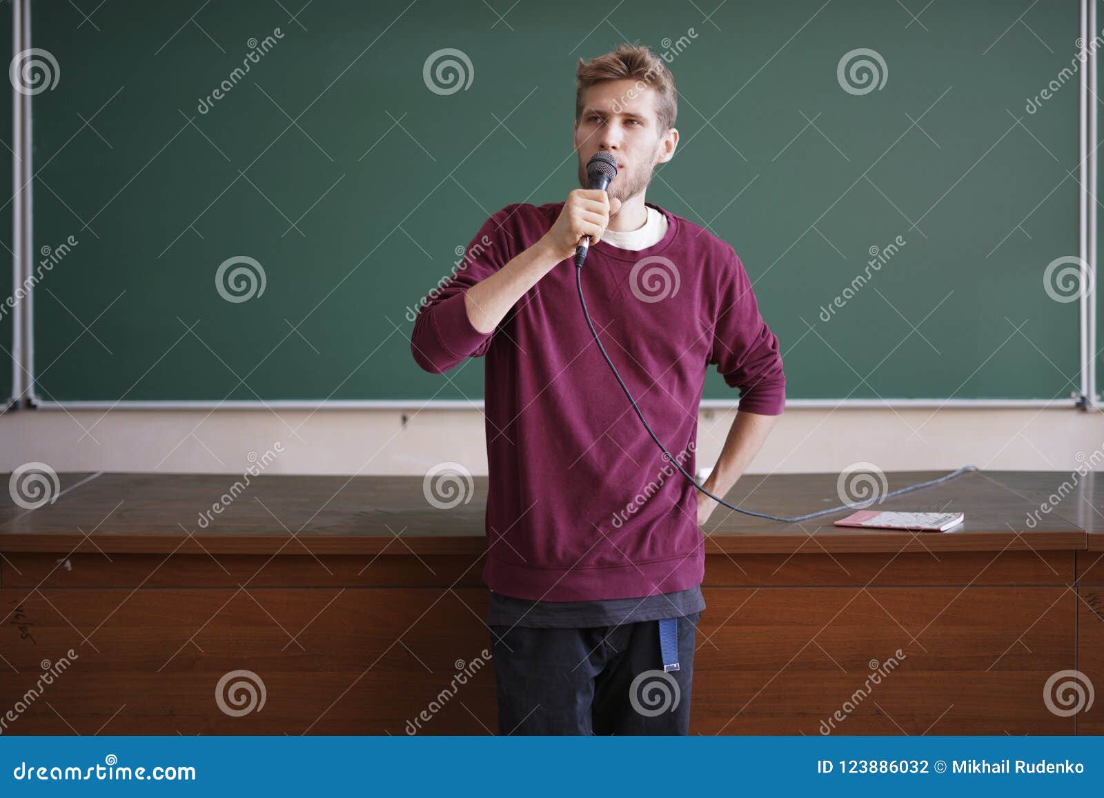 Young Professor Teacher Speaking with the Microphone in the Lecture ... Young Professor Teacher Speaking with the Microphone in the Lecture ...