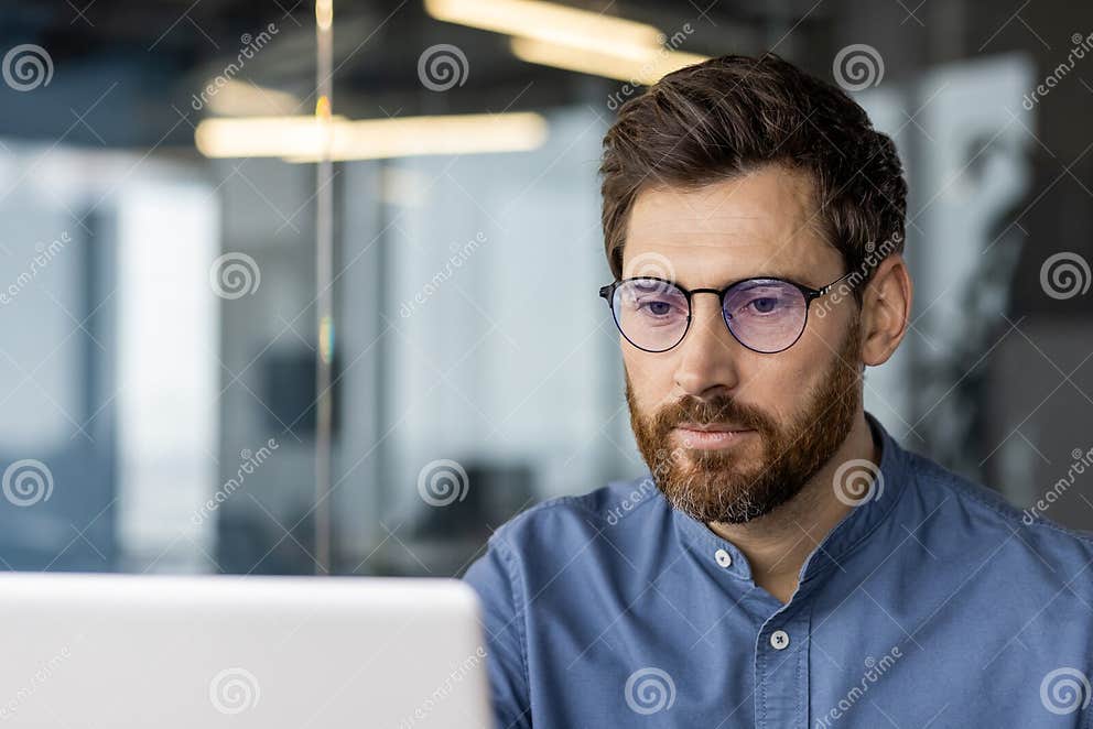 Young Programmer and Developer Sitting in Modern Office Wearing Glasses ...