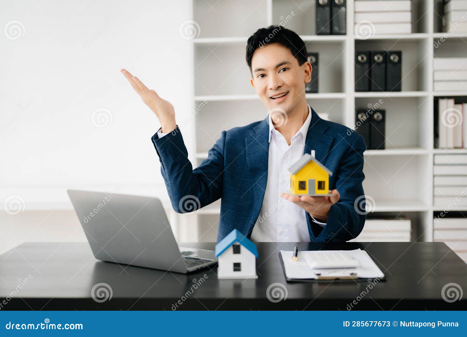Young Real Estate Agent Worker Working with Laptop and Tablet at Table ...