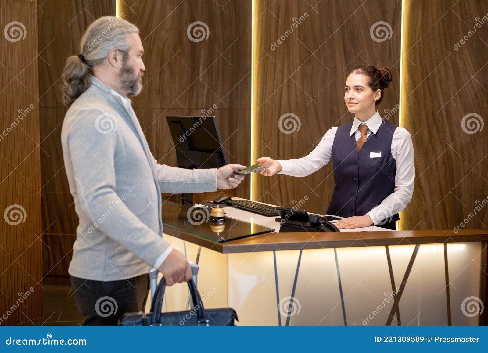 Young Receptionist Taking Documents of Mature Man Stock Image - Image ...