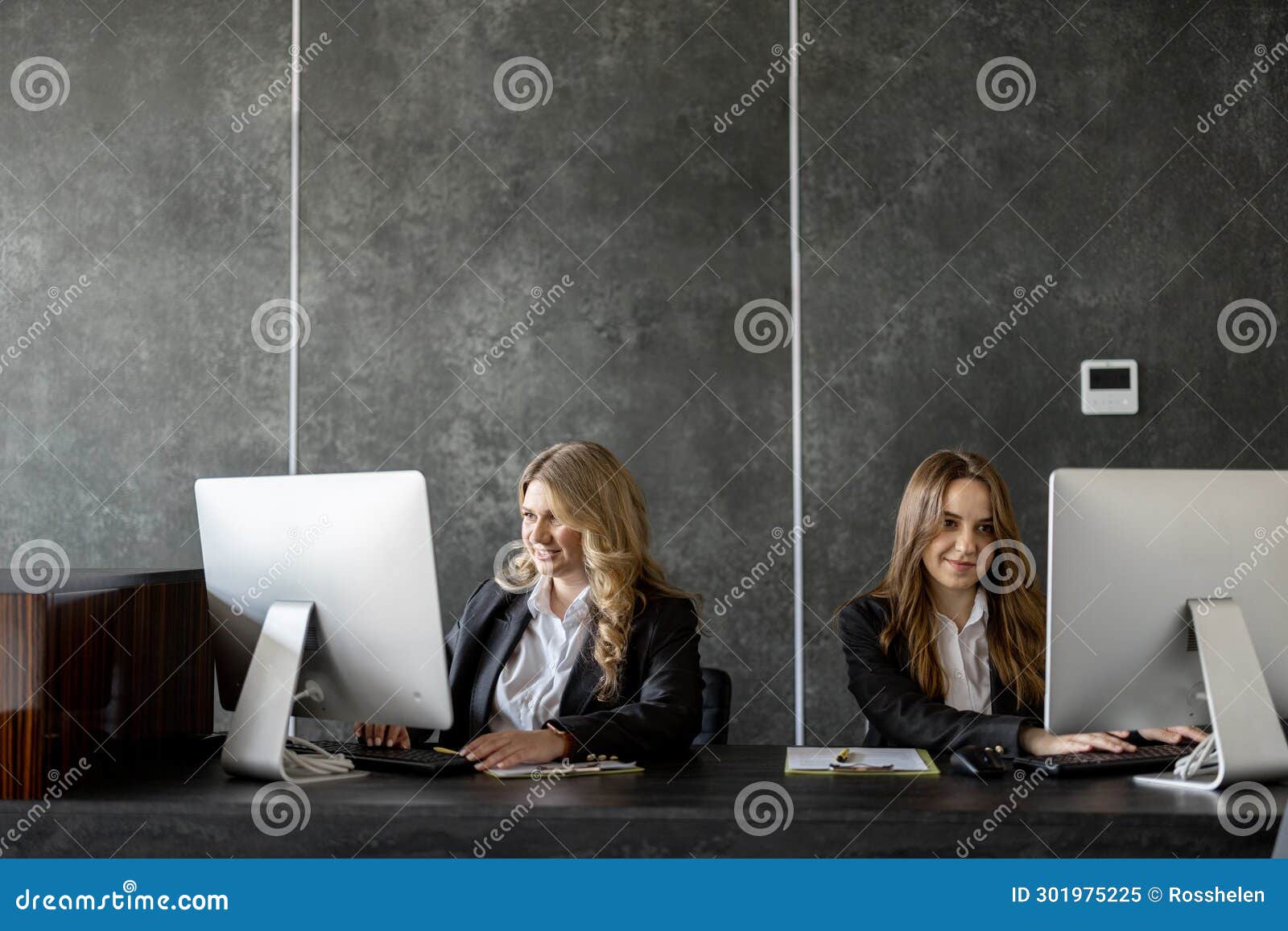 Young Receptionists at the Reception Desk Stock Image - Image of ...