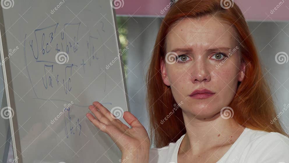 Young Red Haired Woman Looking Puzzled while Solving Math Problem Stock ...