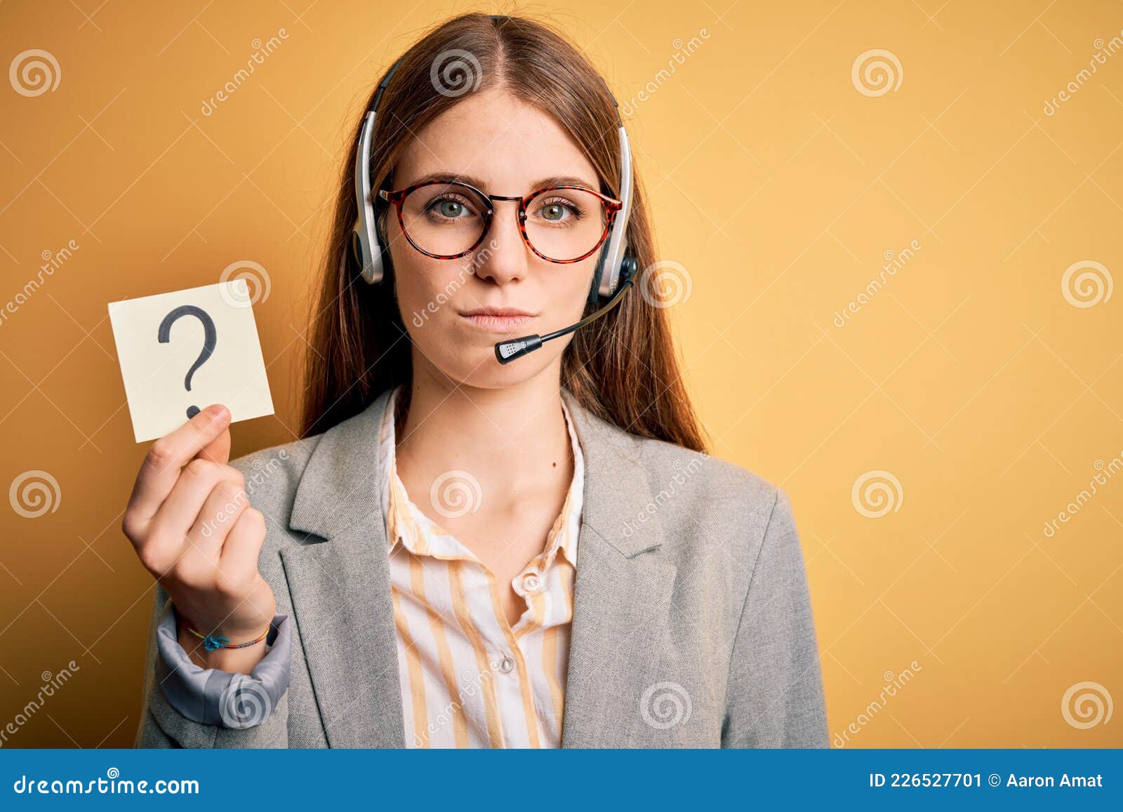 Young Redhead Call Center Agent Woman Using Headset Holding Question ...