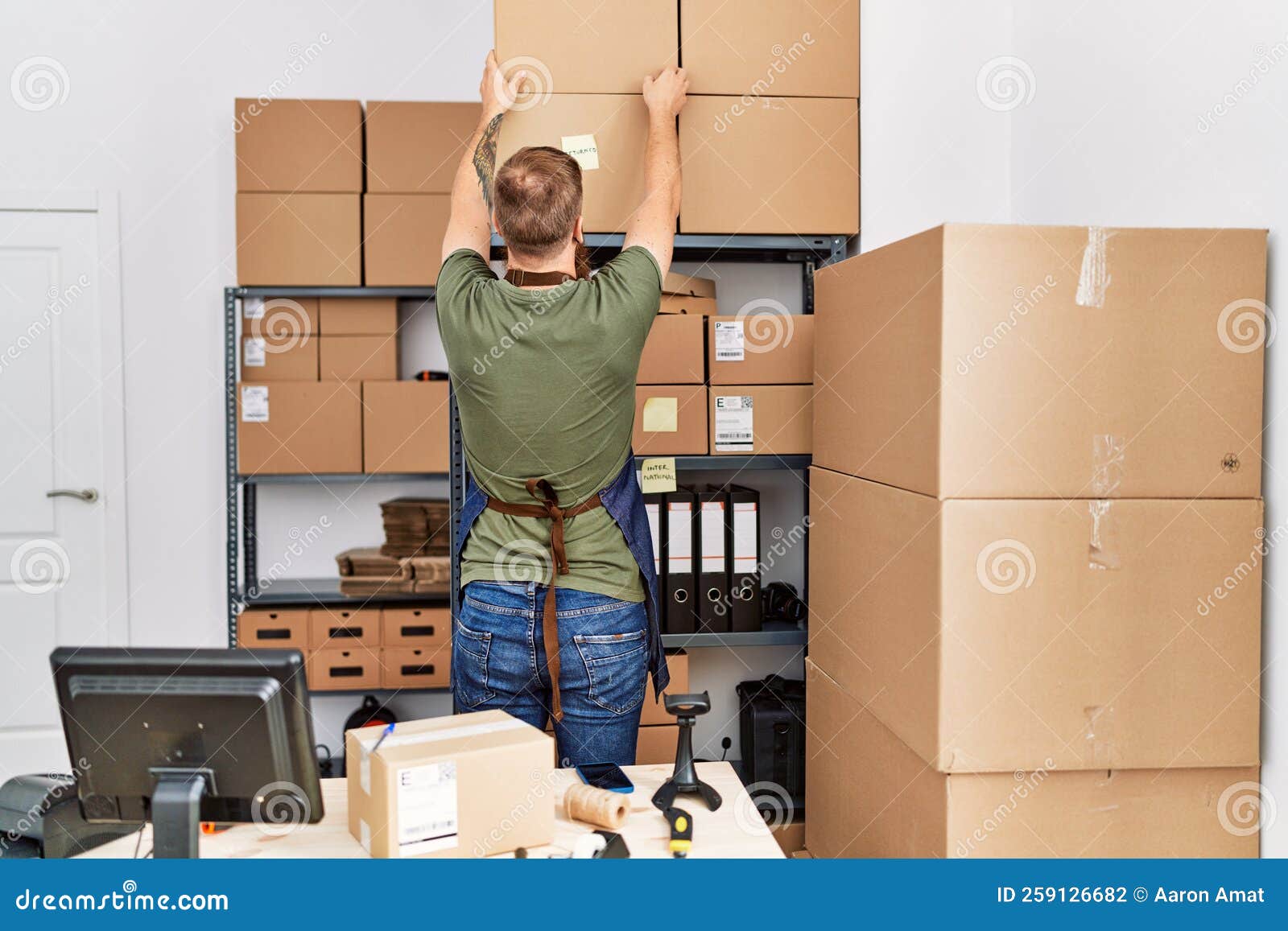 Young Redhead Man Business Worker on Back View Organizing Packages at ...
