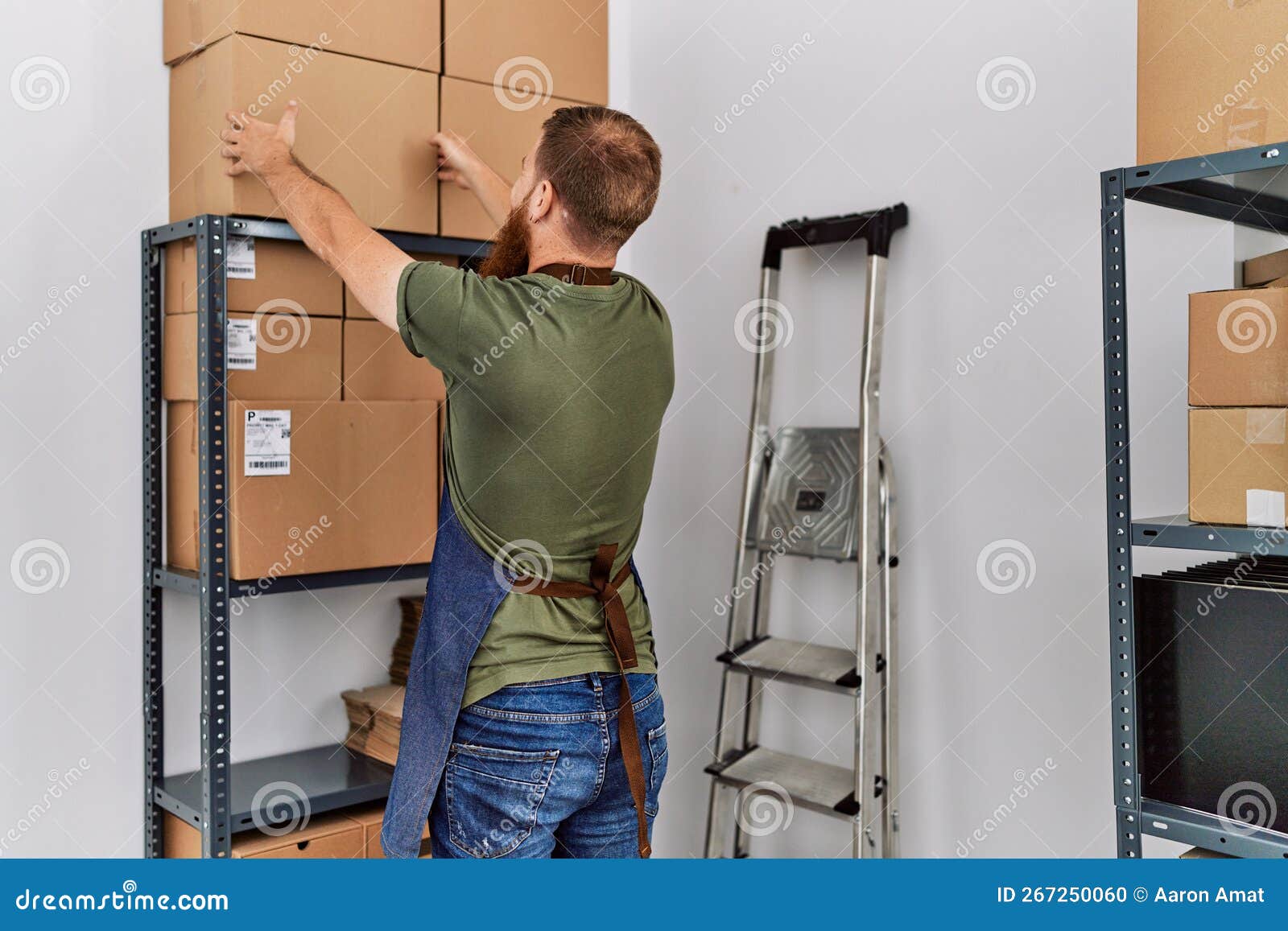 Young Redhead Man Business Worker on Back View Organizing Packages at ...
