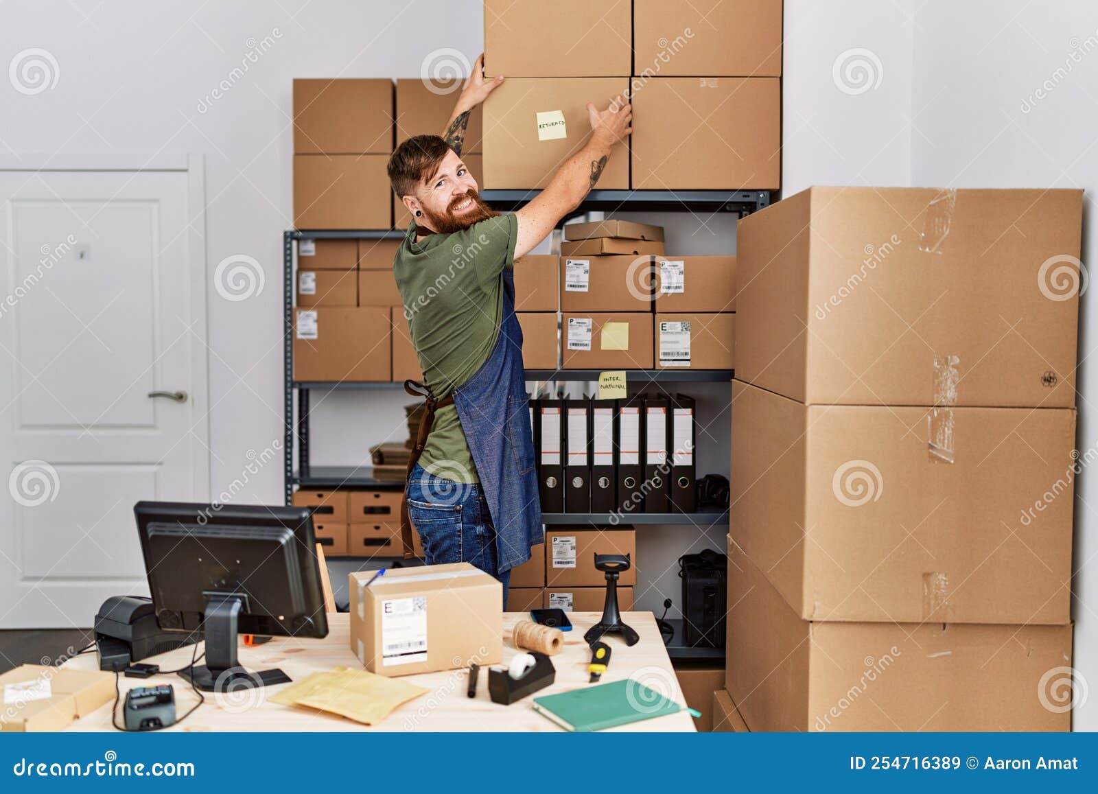 Young Redhead Man Business Worker Organizing Packages at Office Stock ...