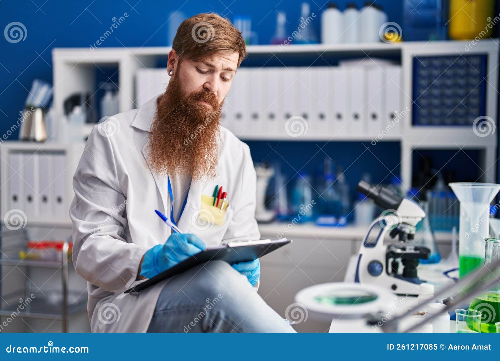 Young Redhead Man Scientist Writing Report Working at Laboratory Stock ...