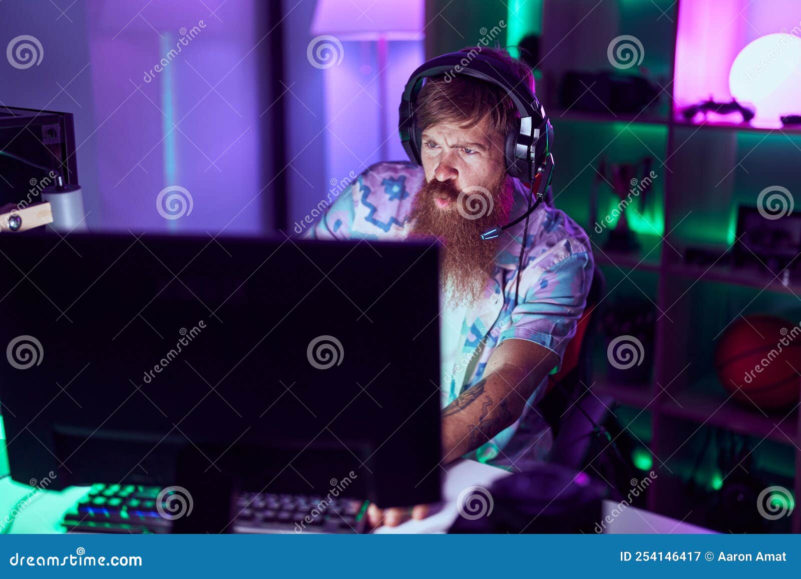 Young Redhead Man Streamer Playing Video Game Using Computer at Gaming ...