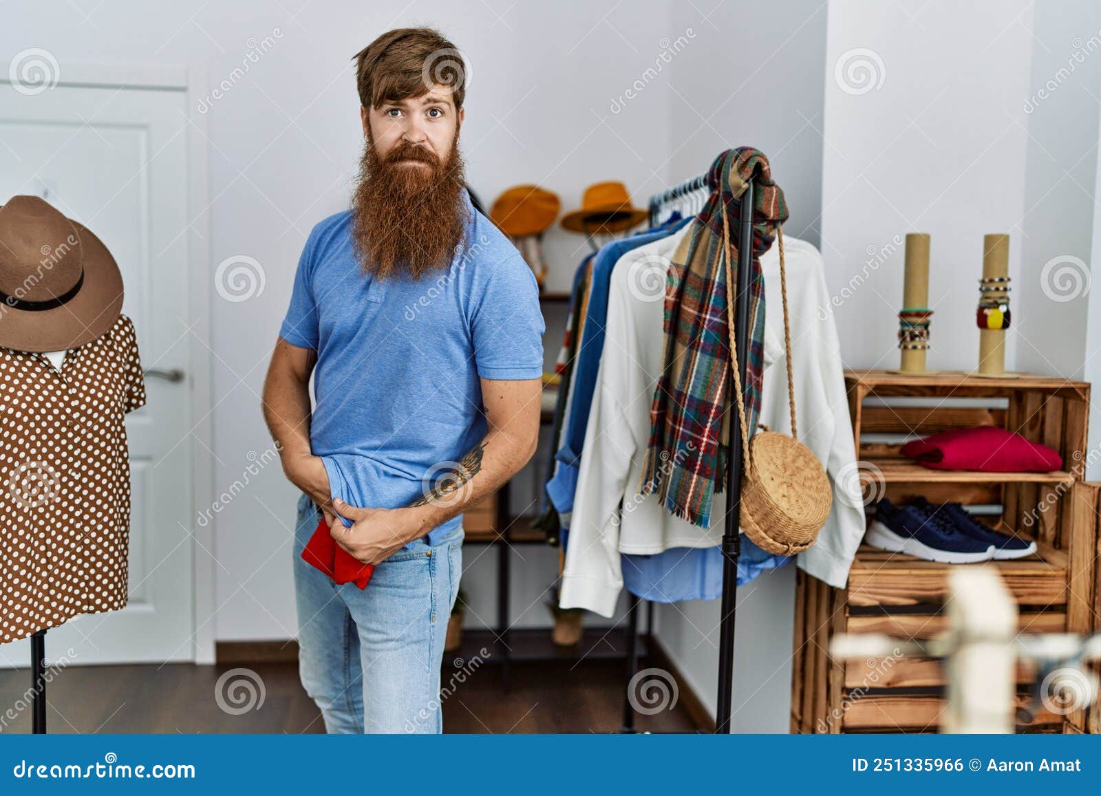 Young Redhead Robber Man Stealing Shirt at Clothes Store Stock Photo ...