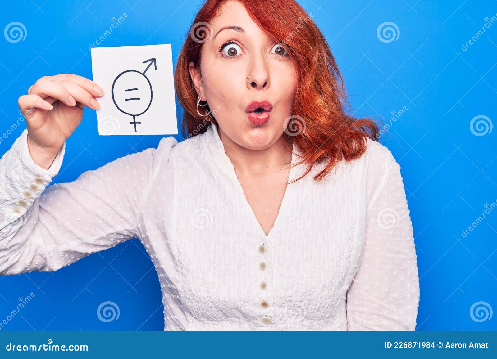 Young Redhead Woman Asking For Sex Discrimination Holding Paper With