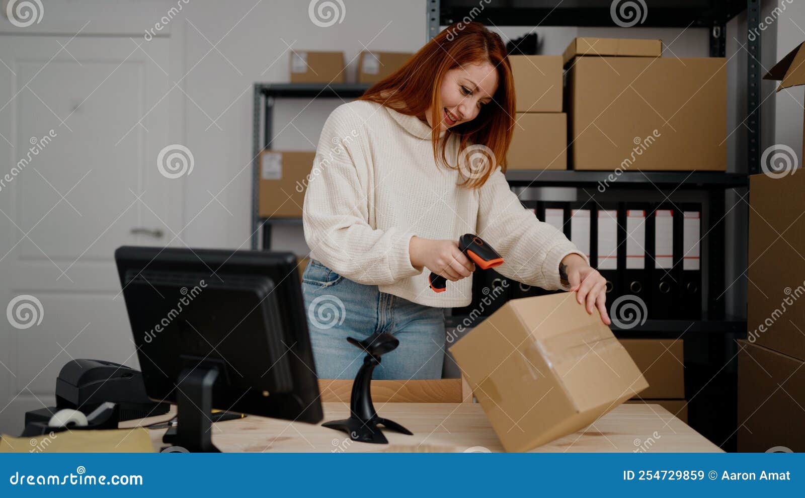 Young Redhead Woman Ecommerce Business Worker Scanning Package Barcode ...