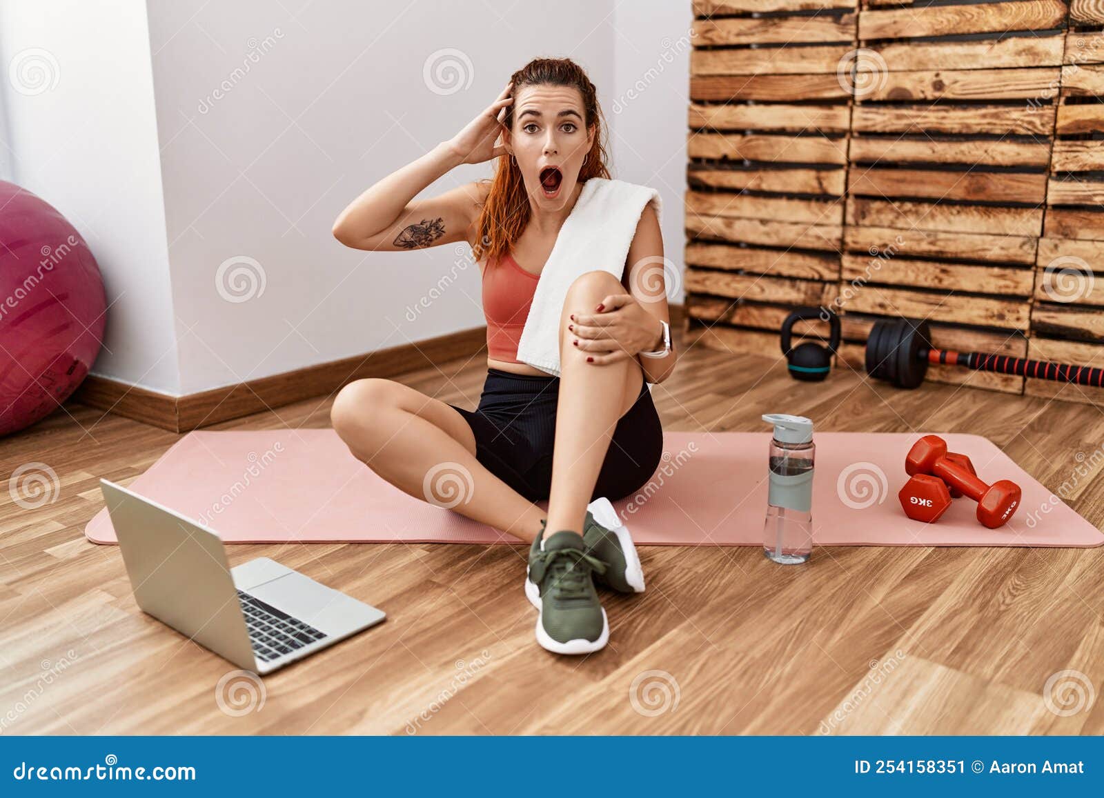 Young Redhead Woman Watching Training Tutorial at the Gym Crazy and ...