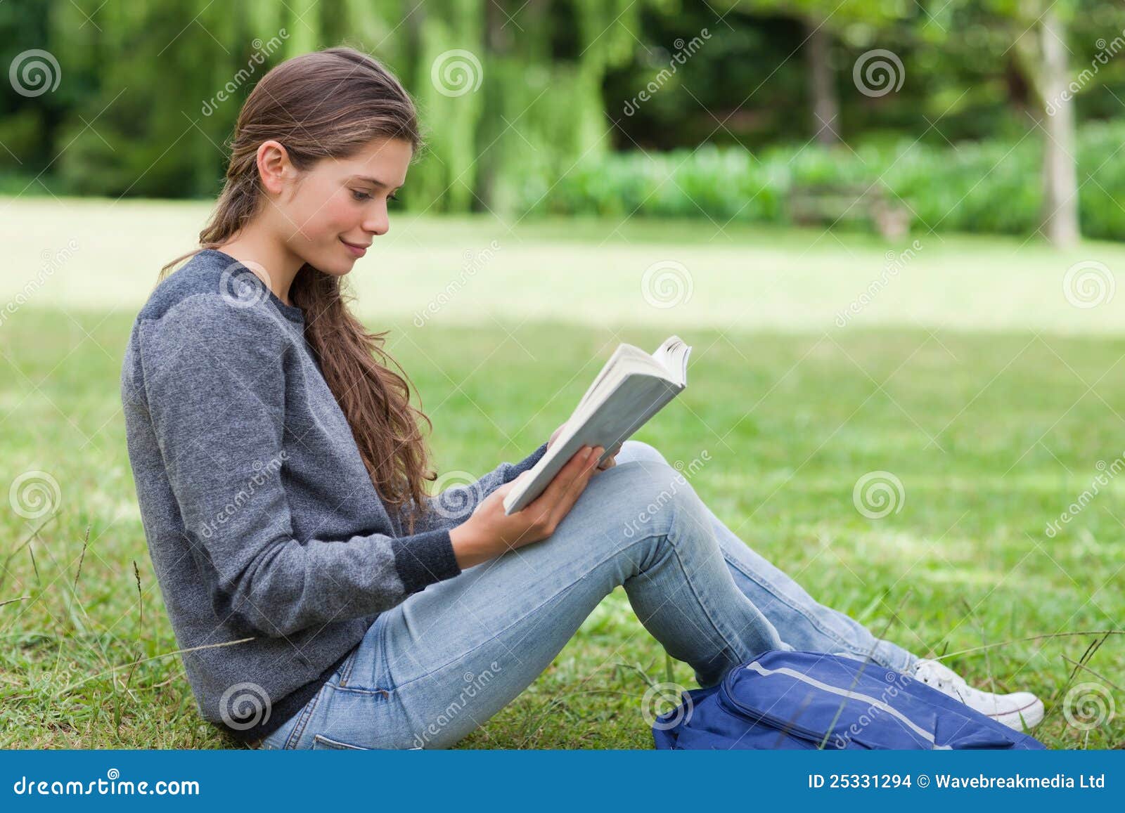 Young Relaxed Girl Reading a Book while Sitting Stock Photo - Image of ...