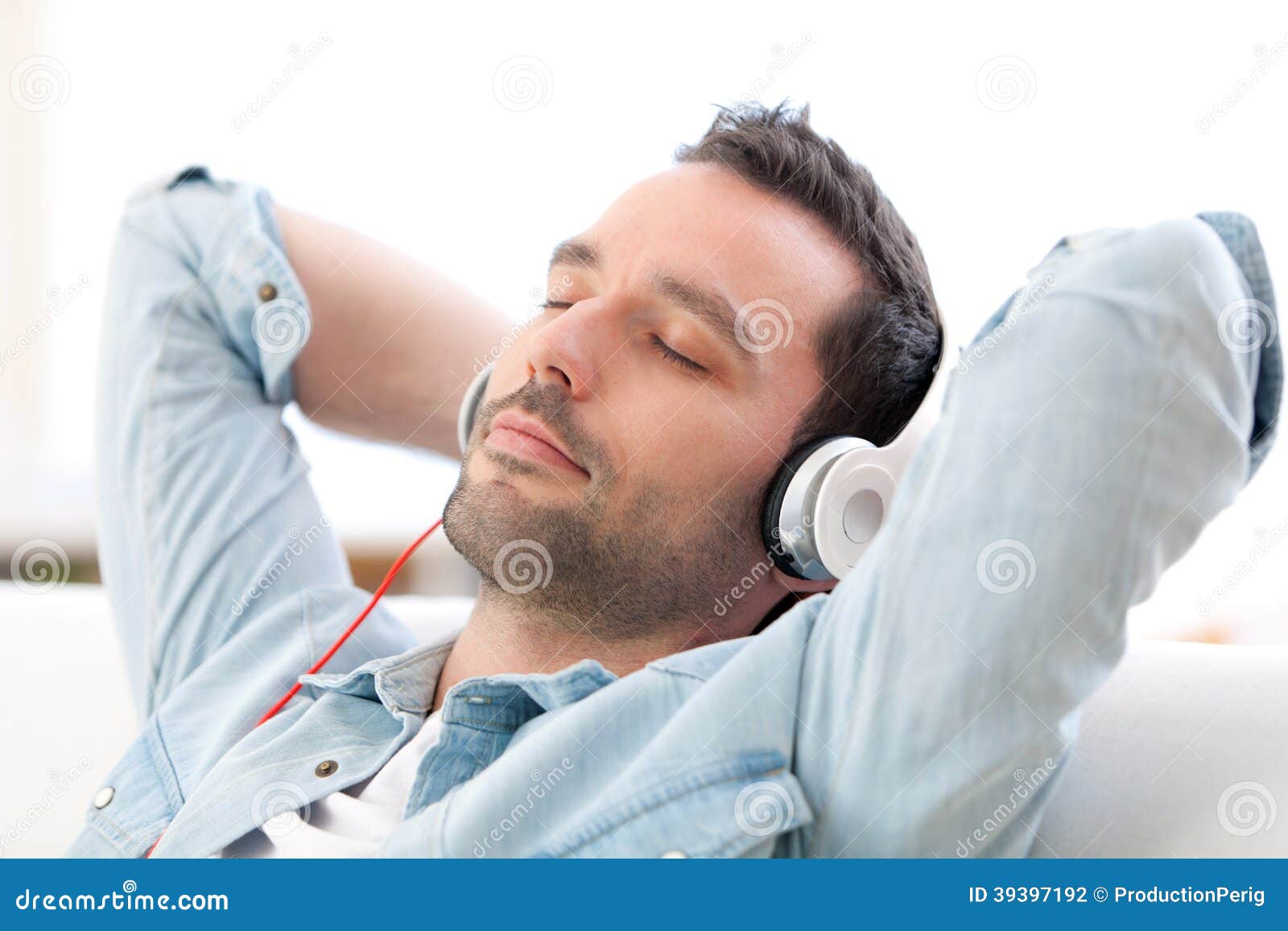 Young Relaxed Man Listening Music in a Sofa Stock Photo - Image of ...