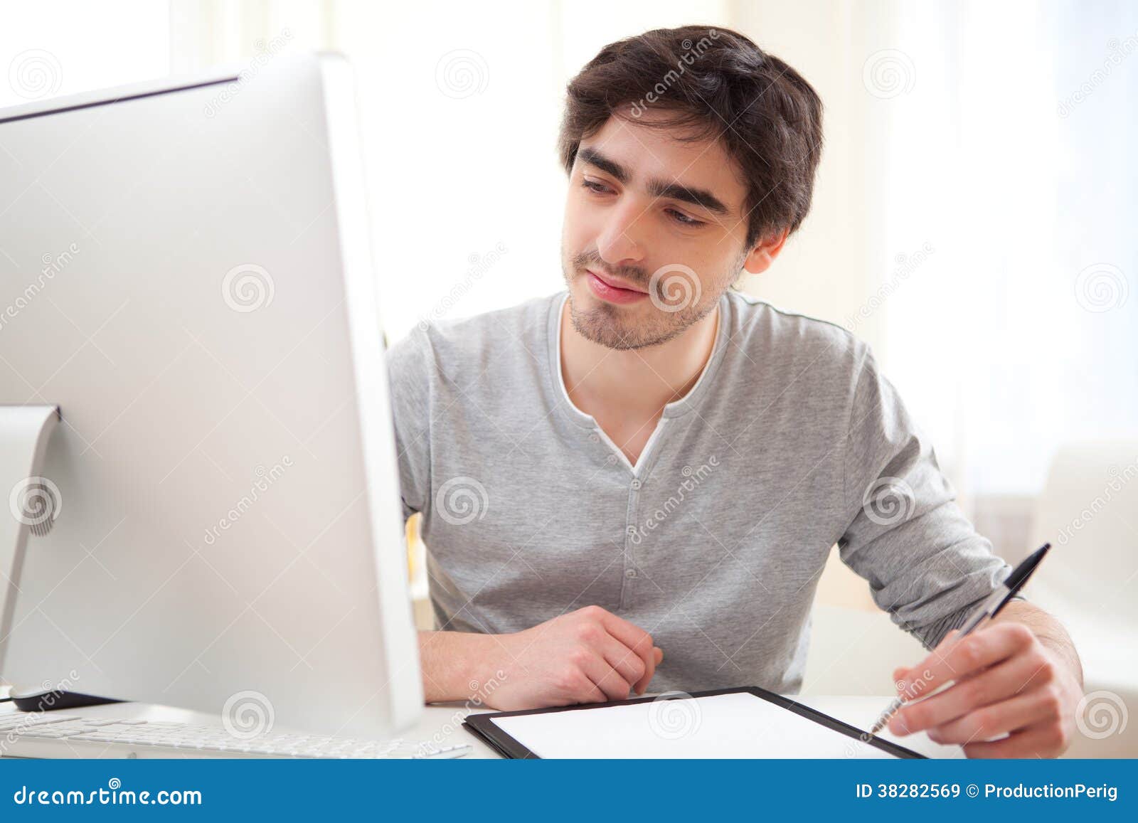 Young Relaxed Men Writting at the Office Stock Image - Image of ...