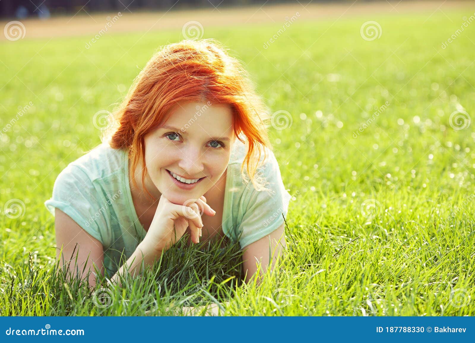 Young Relaxing Redhead Girl Lying On The Grass Woman Relaxation