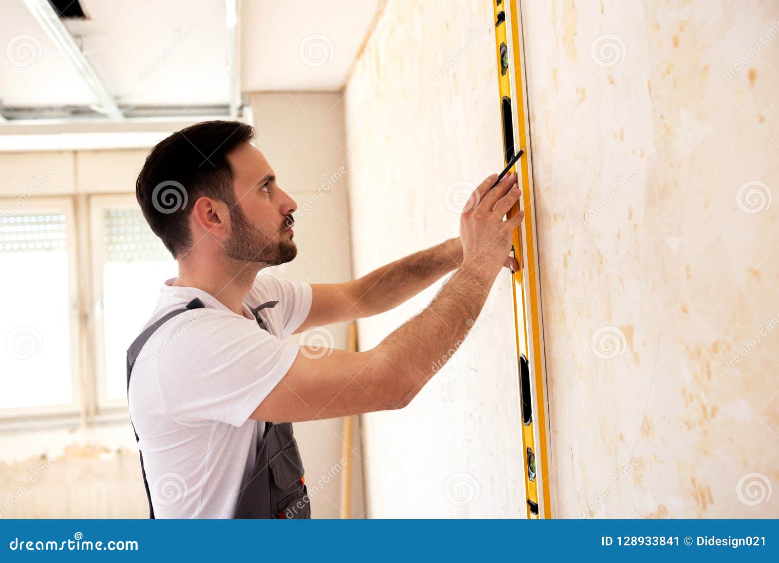 Young Repairman Checking Whether a Surface is Leveled Stock Image ...